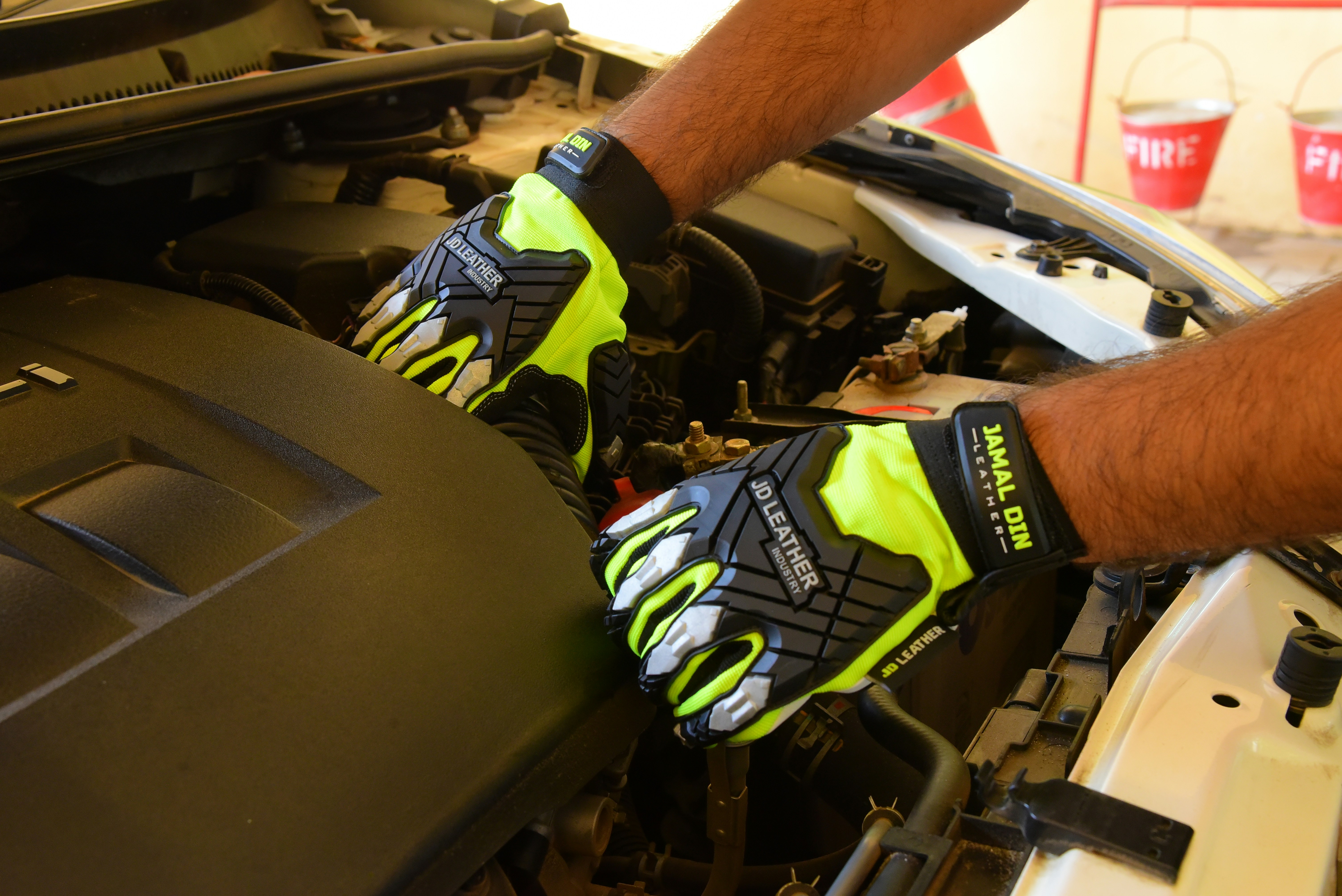 Hands in Action: A Mechanic’s Precision under the Car Hood