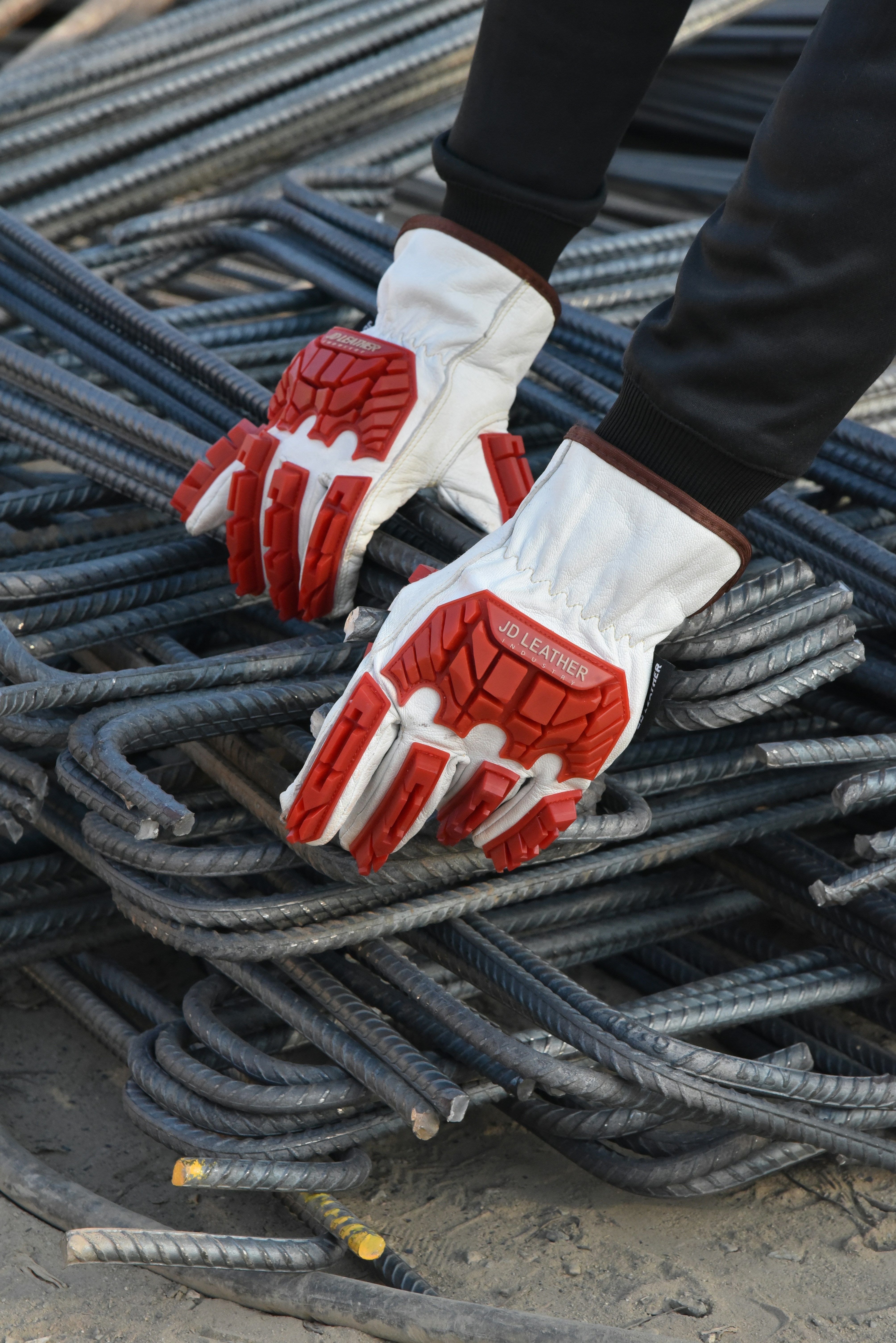 Gloved Hands Grasping Rebar: A Worker’s Grip on Steel Lines