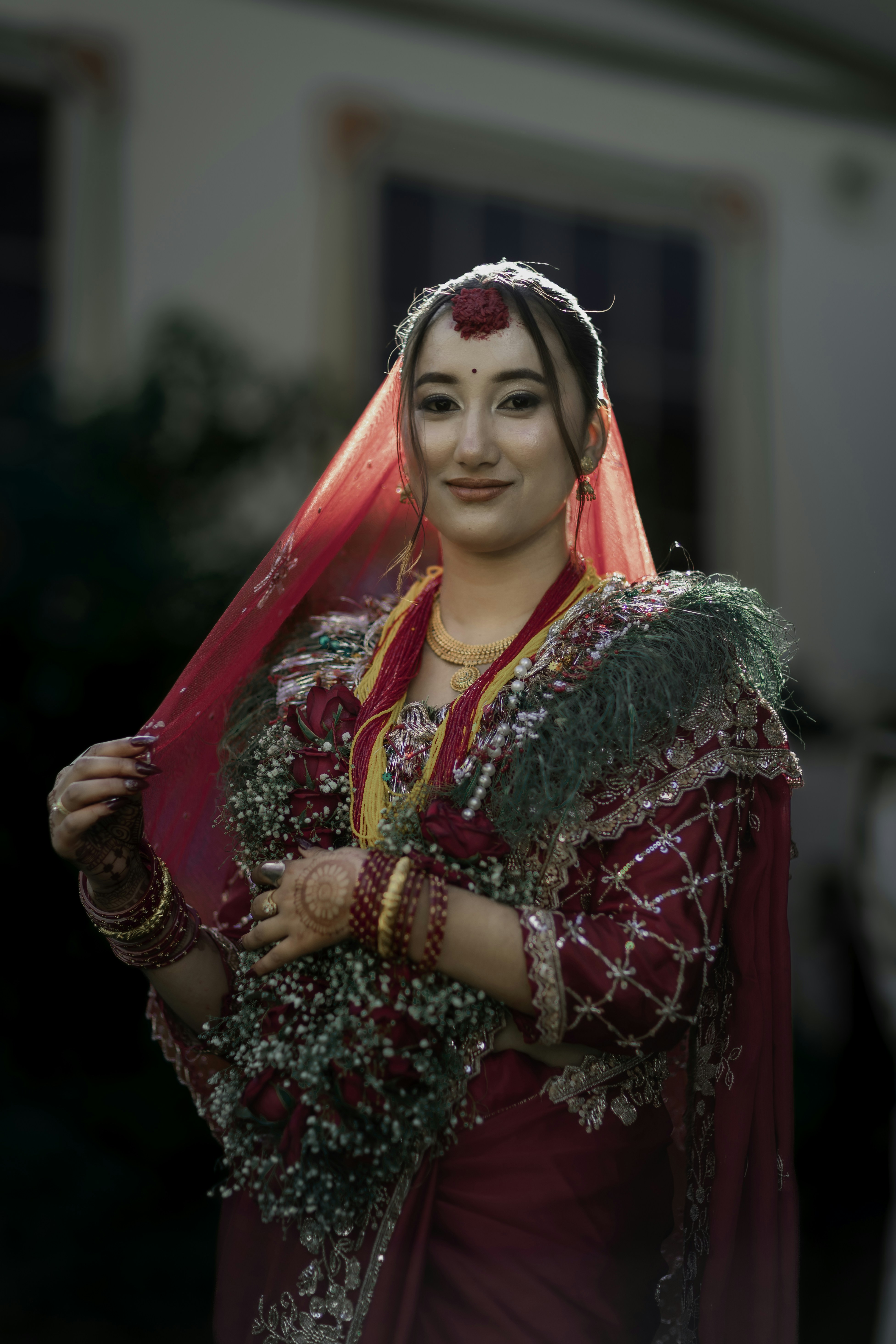 Vibrant bridal portrait: intricate attire and poised elegance
