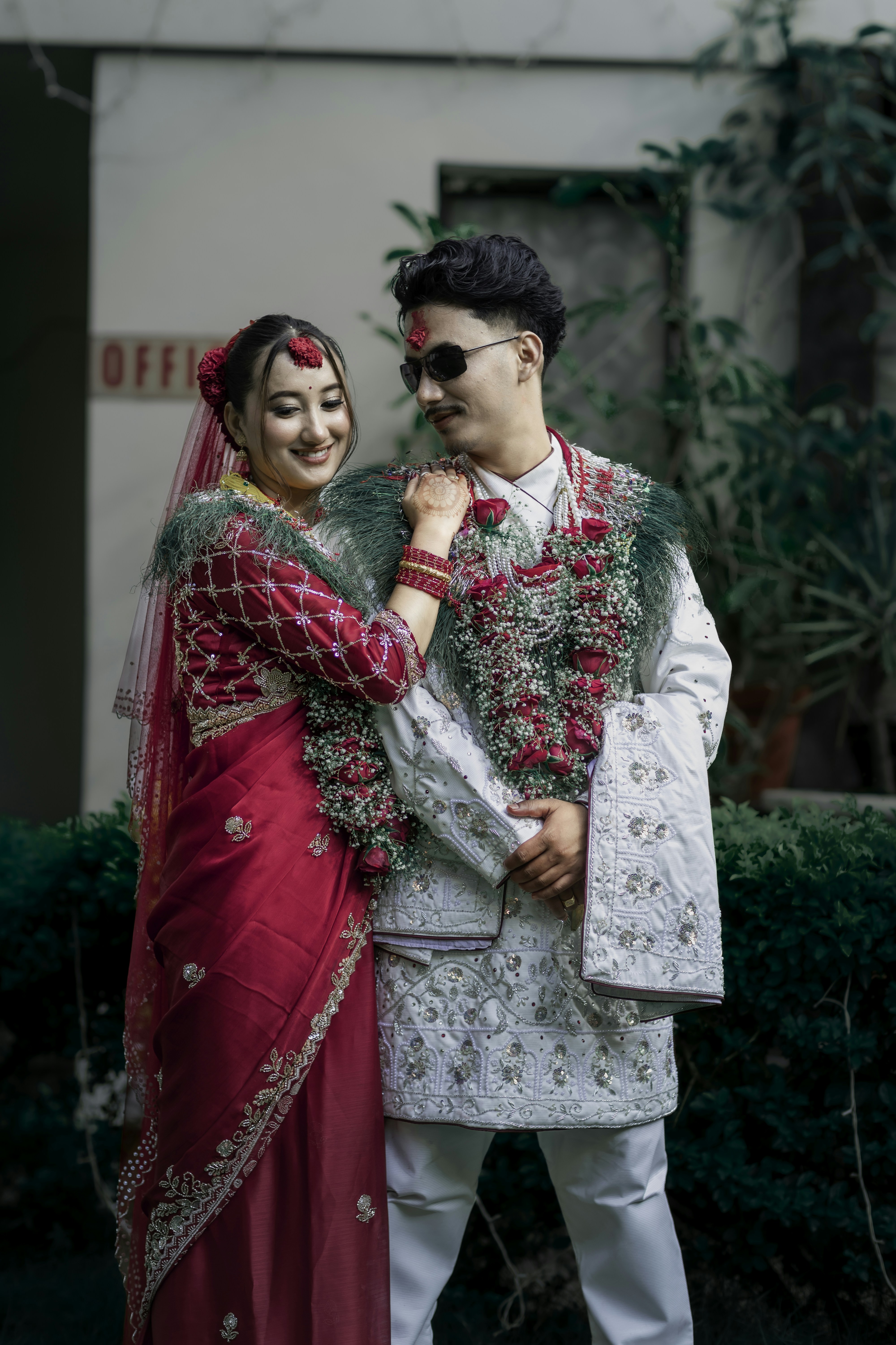 Bride and Groom in Festive Attire Share a Tender Moment