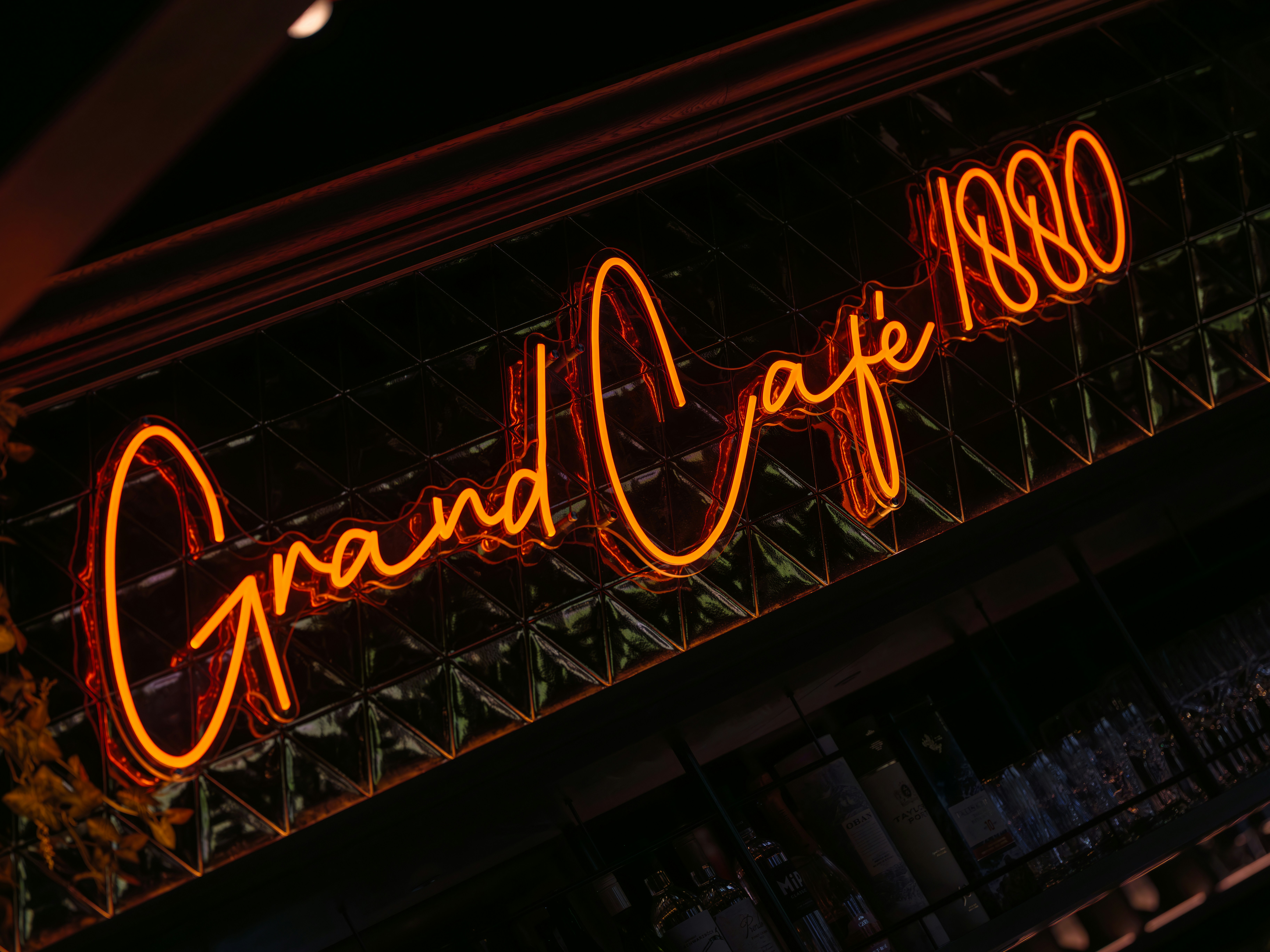 Neon Script over Glass Tiles: Grand Café 1930 Sign
