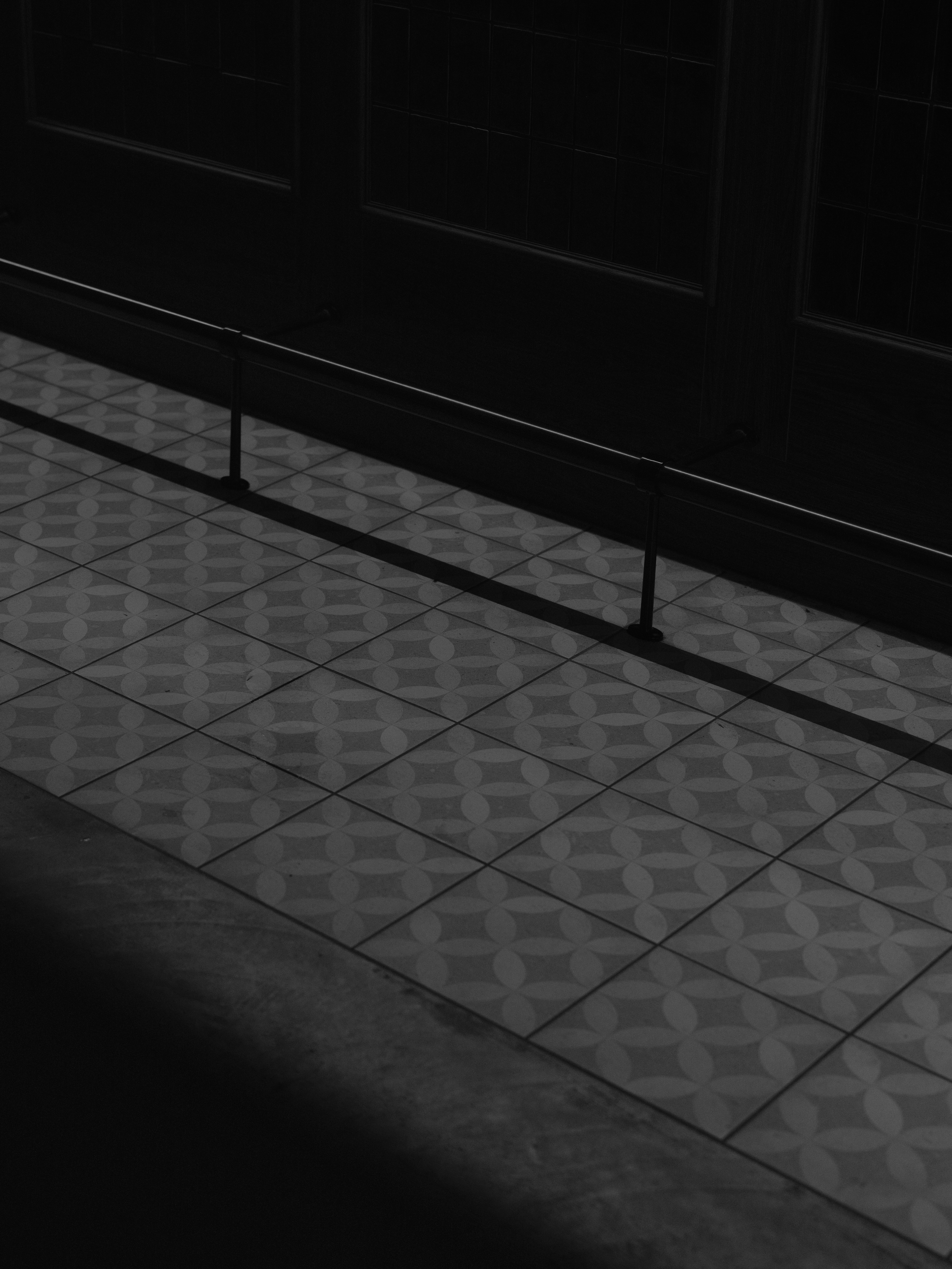Silent Platform Graffiti: A Quiet Tile Edge in Monochrome