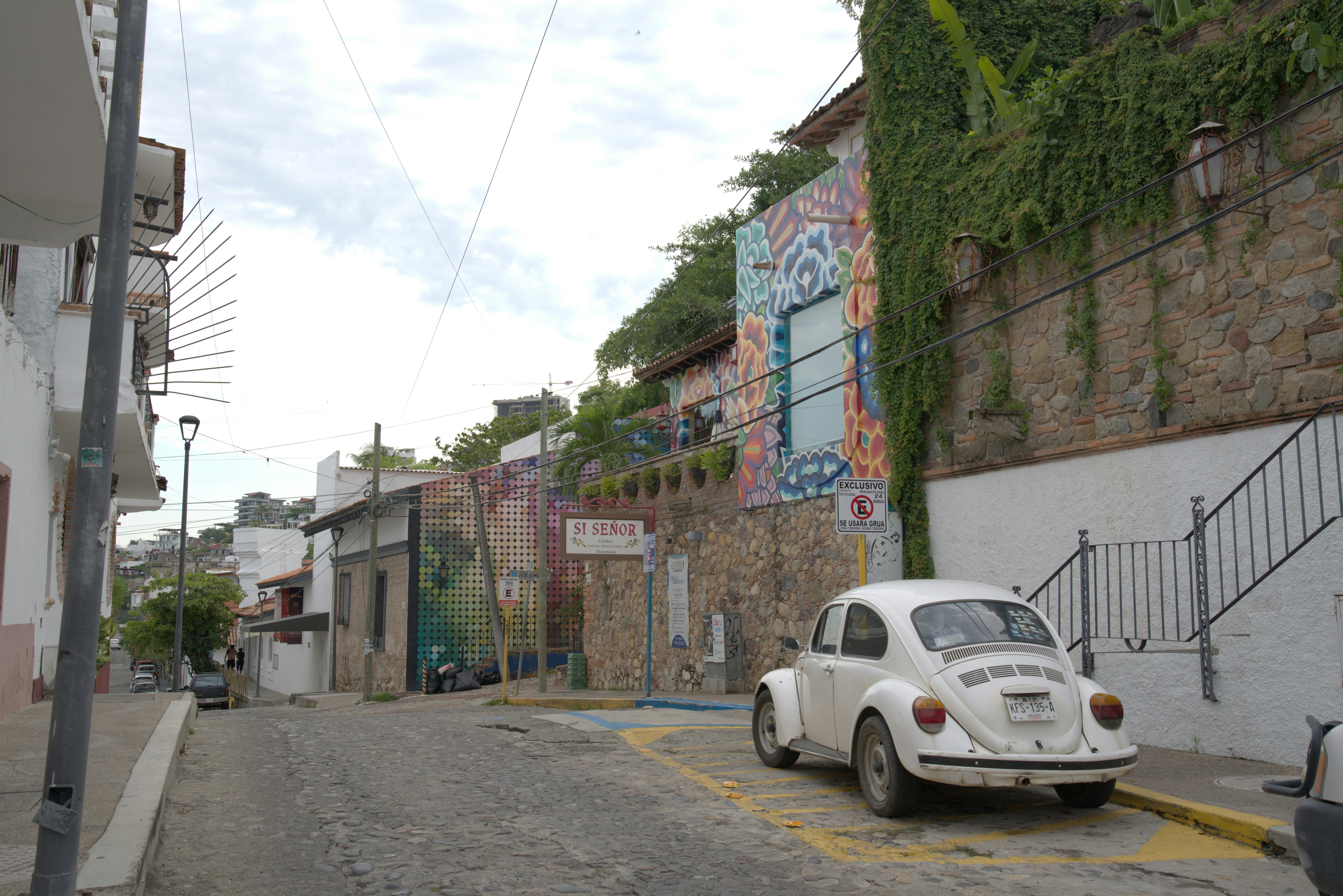 Old Beetle by a Painted Barrio Road