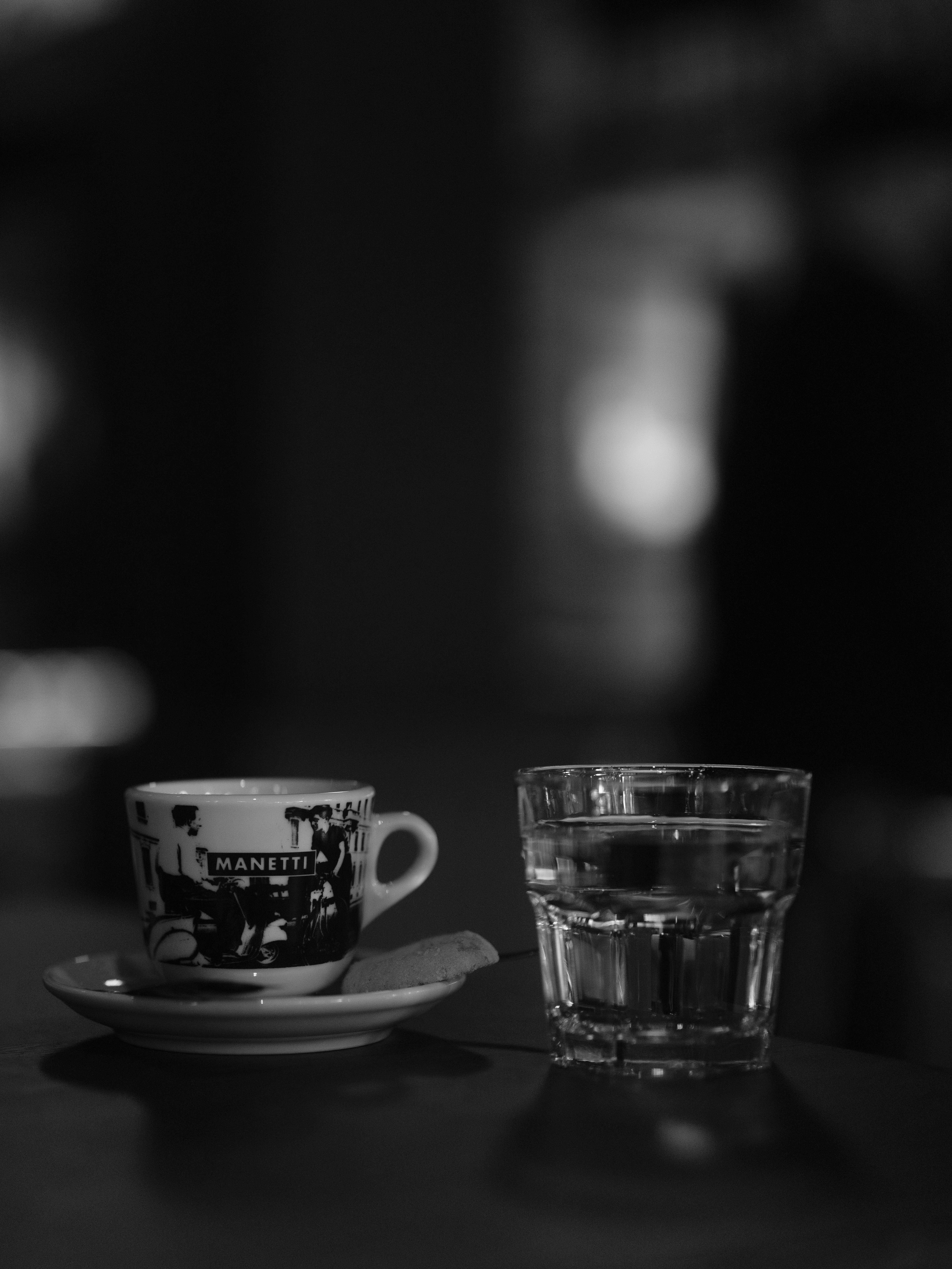 Quiet Espresso Moment: A Ceramic Cup and Glass in Soft Focus