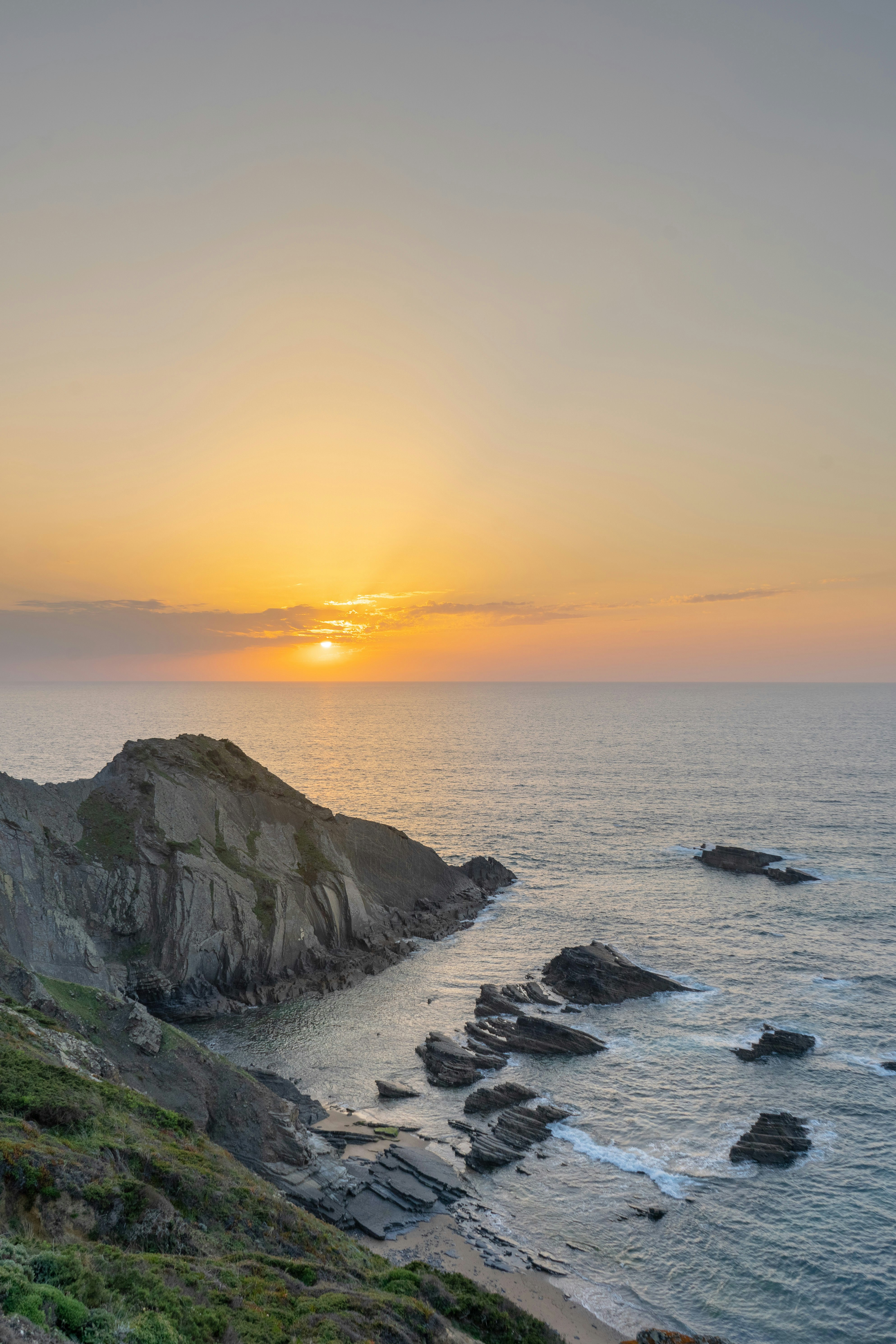 Sunlit Cliffs at Dusk Over the Quiet Sea
