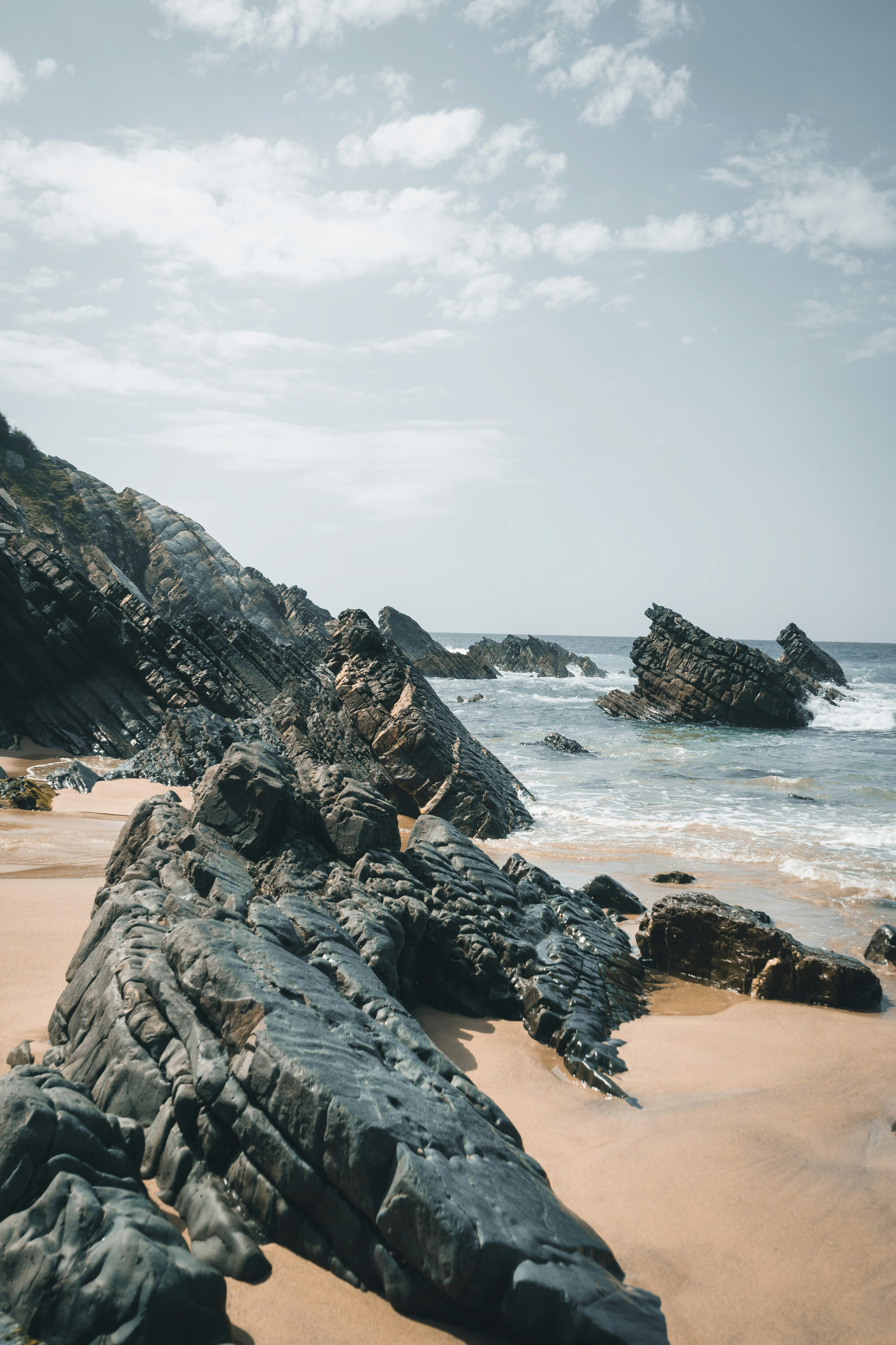 Sea-Wedged Giants: A Rugged Rock Ridge Reaches the Shore