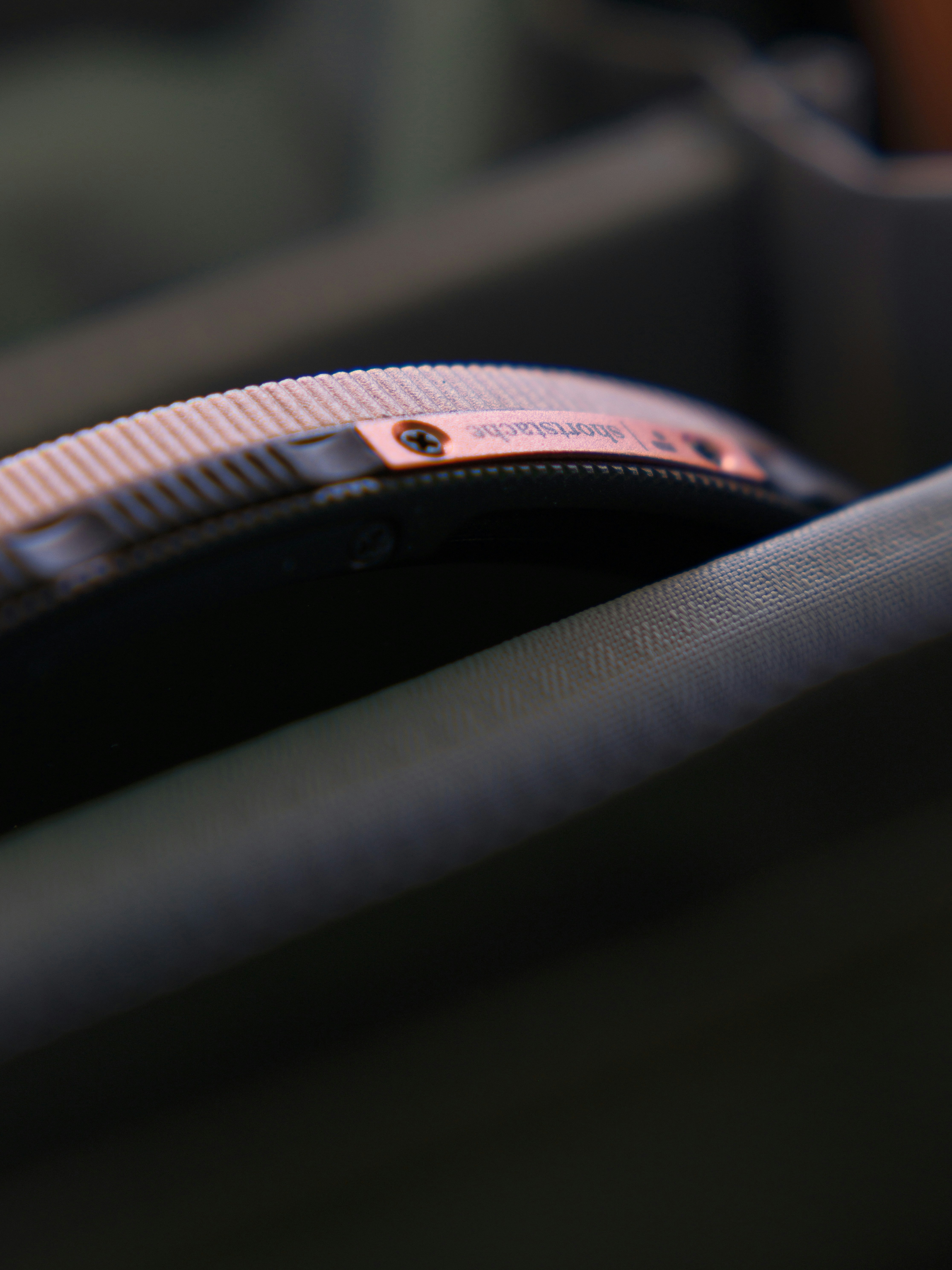 Close-up of a brushed metal ring on a camera lens hood