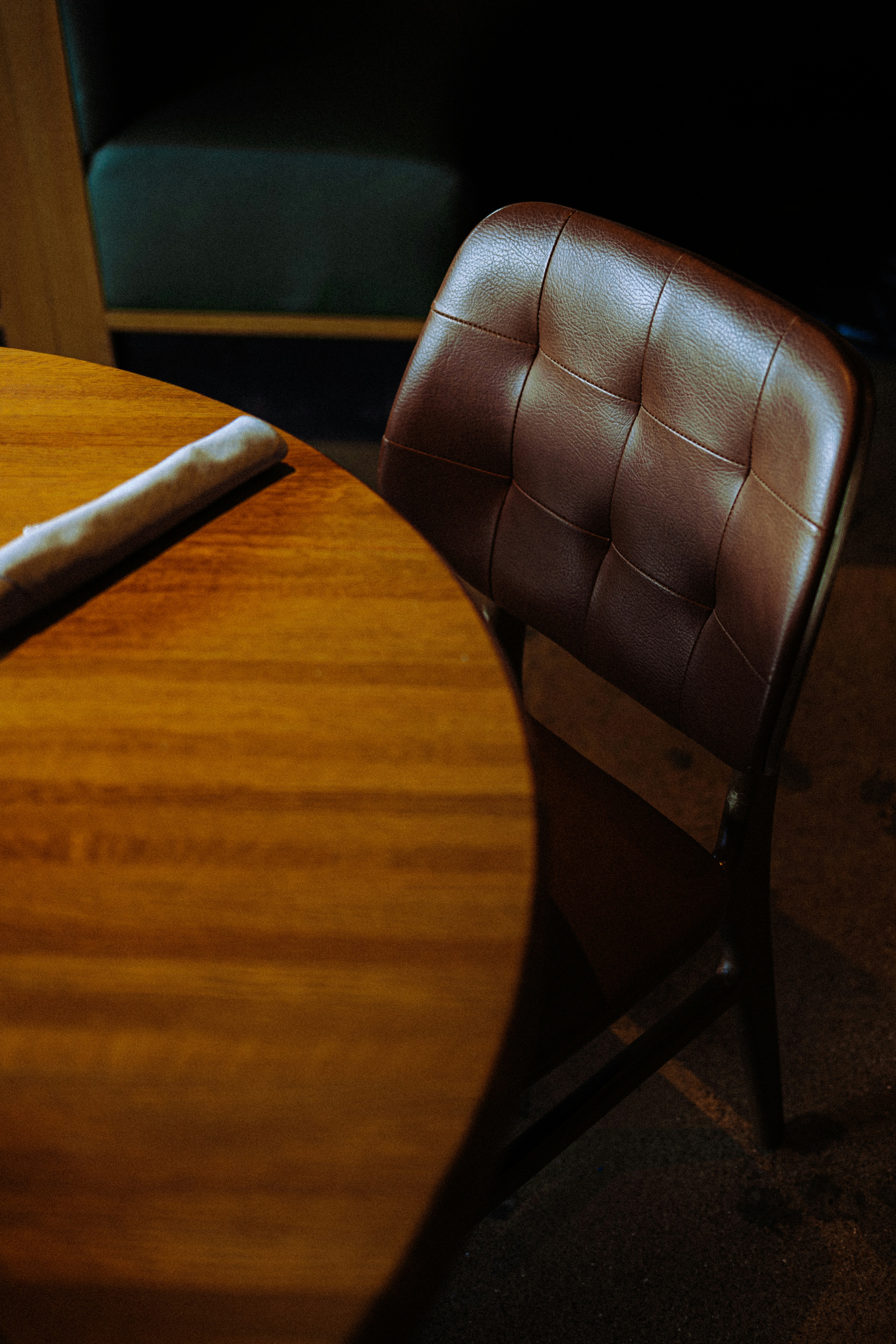 Warm Light, Quiet Corner: A Sunlit Table and Leather Chair