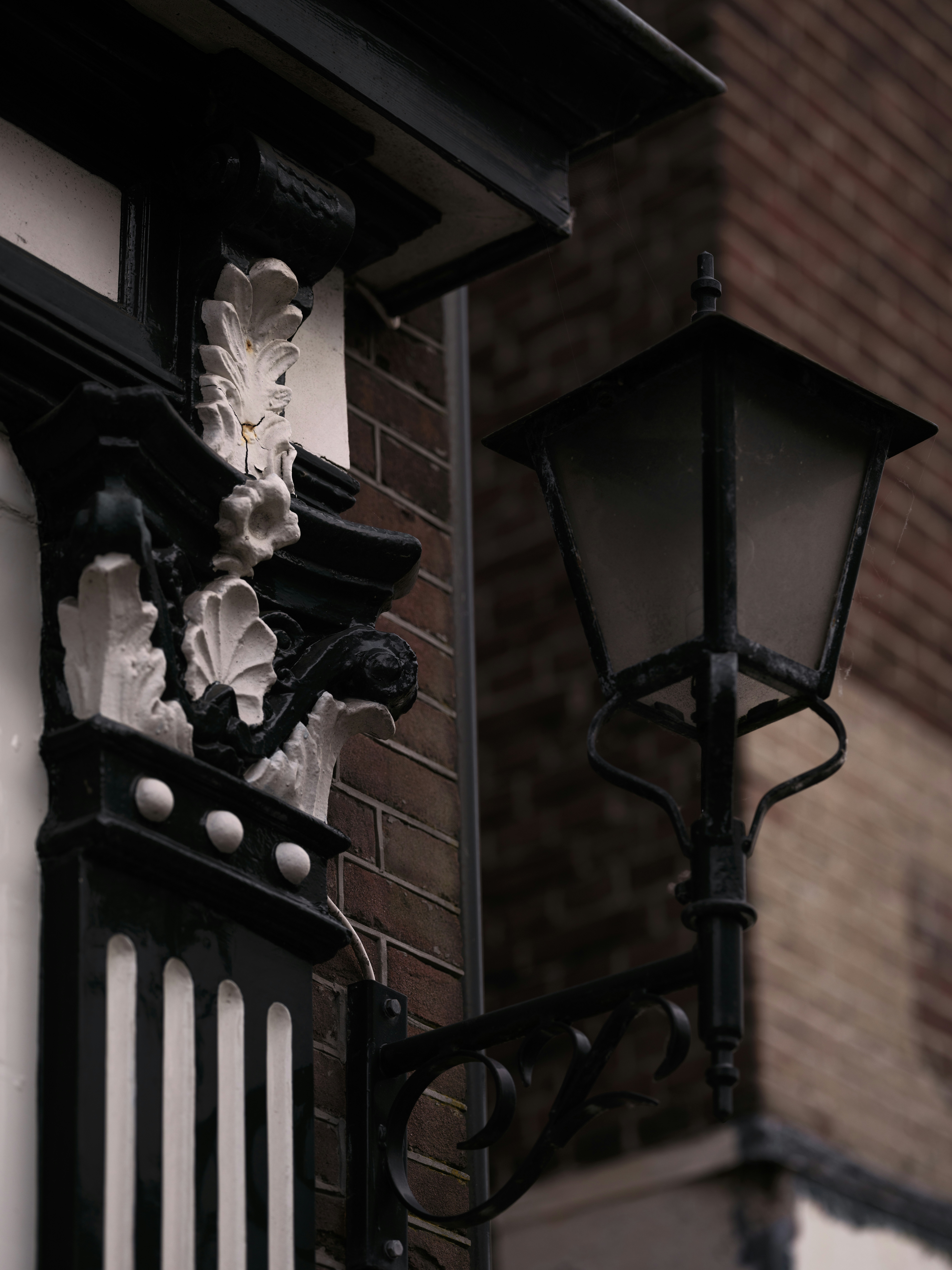 Ornate Lantern on a Brick Façade