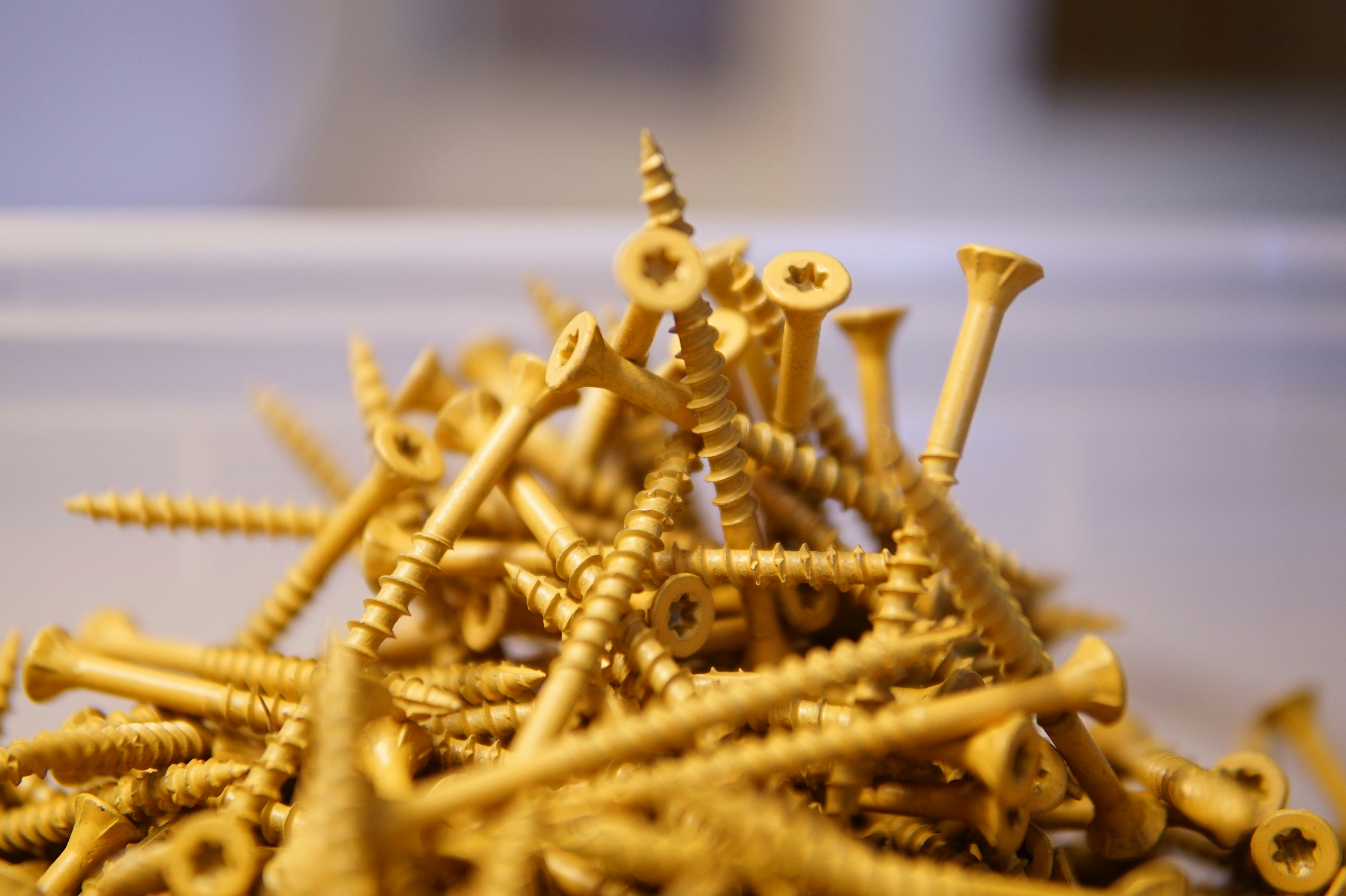 Golden Screws in Focus: A Close-Up Stack of Brass Screws