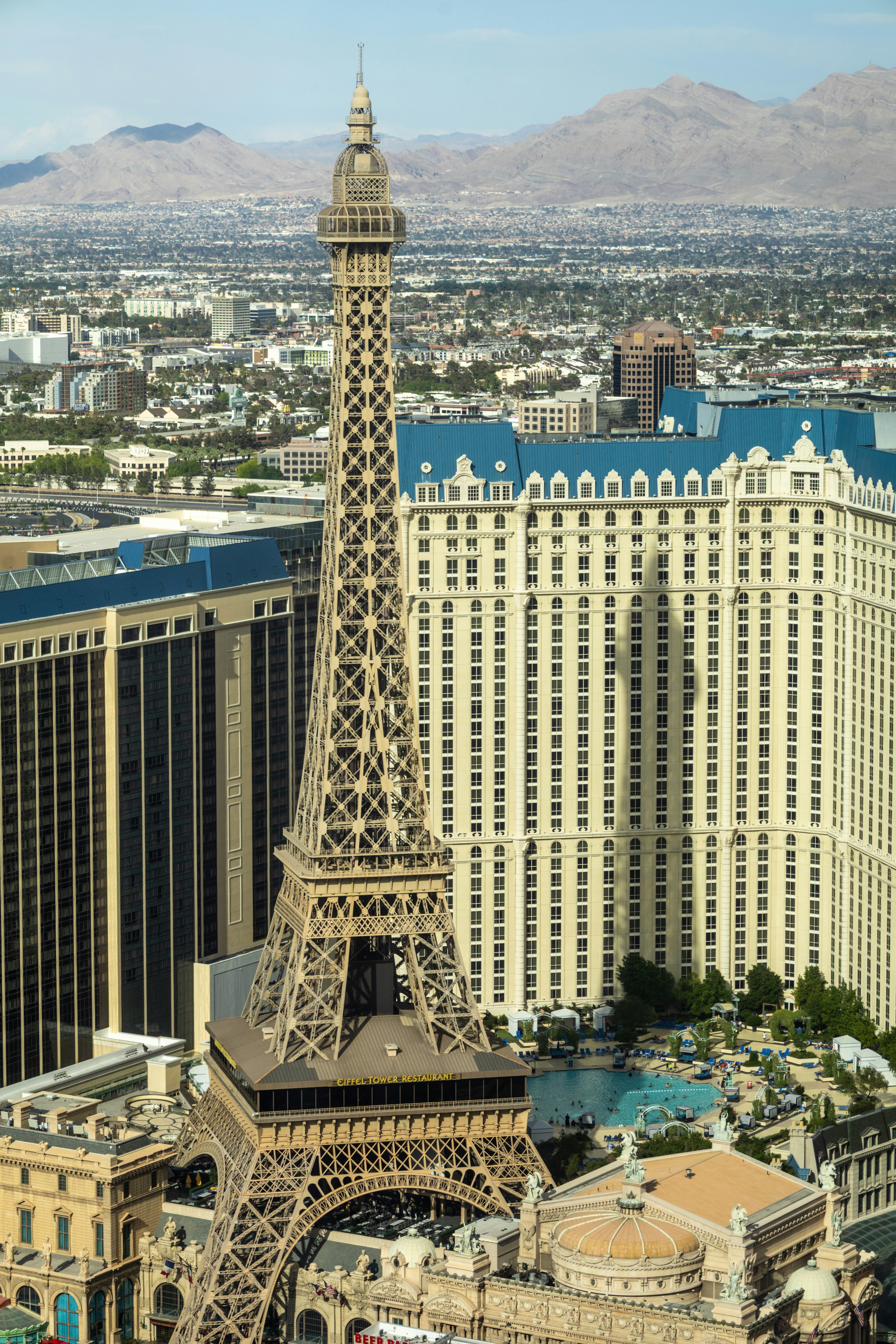 Miniature Eiffel Tower rises over the Venetian facades in a sunlit Las Vegas skyline