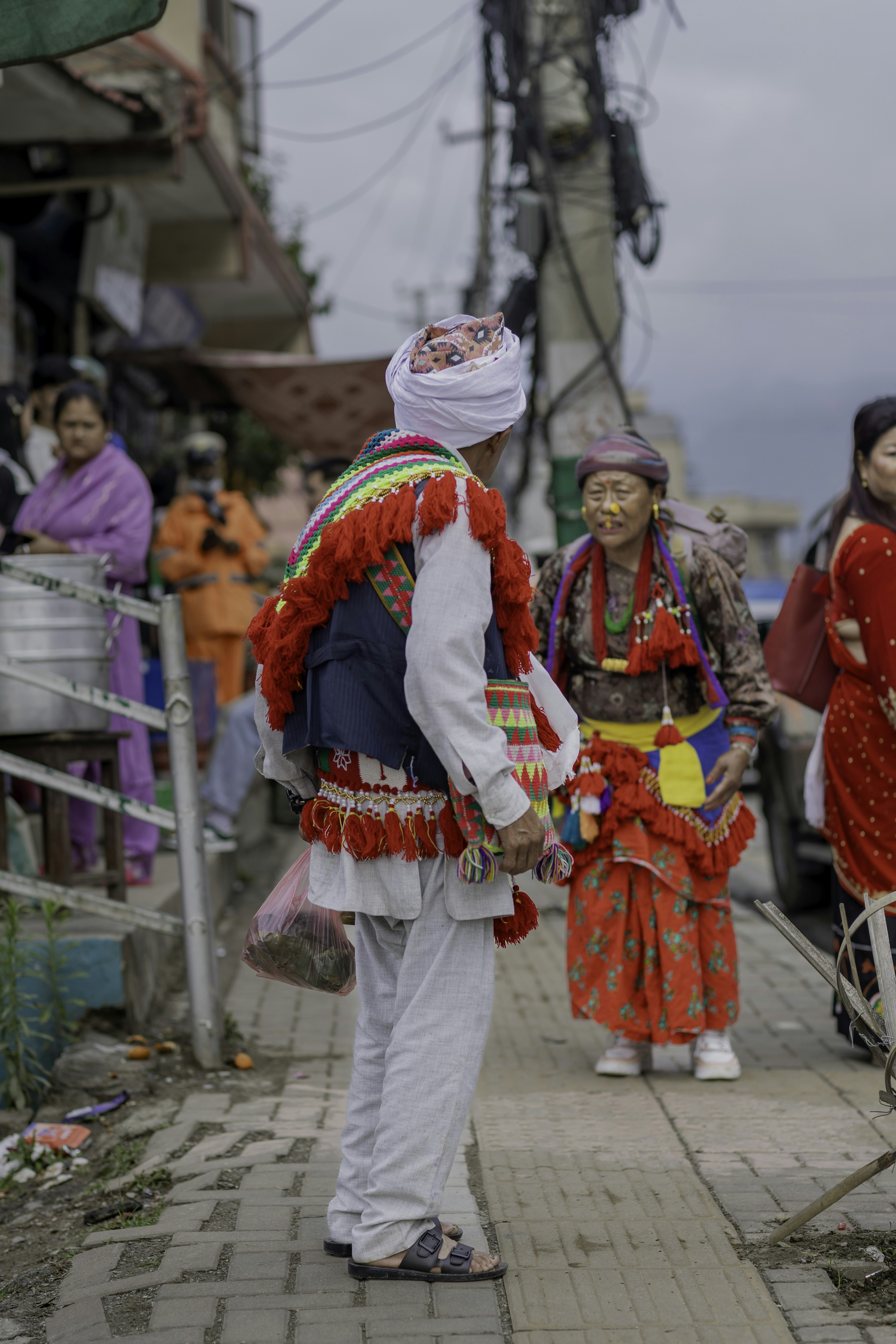 The Turbaned Exchange: A Traditional Tailored Moment on a Busy Nepali Street