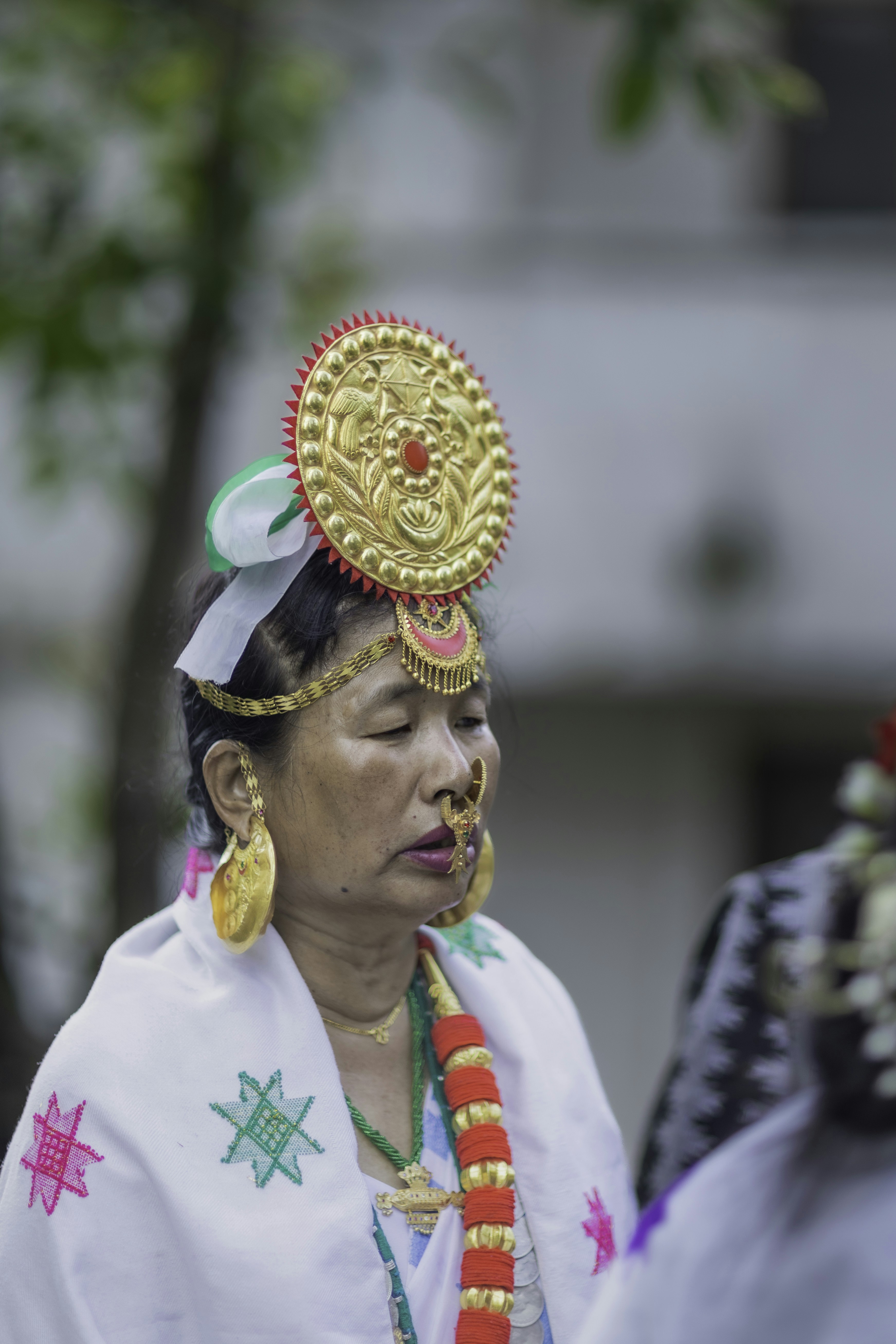 Regal Adornments: A Woman in Traditional Headdress During a Cultural Ceremony