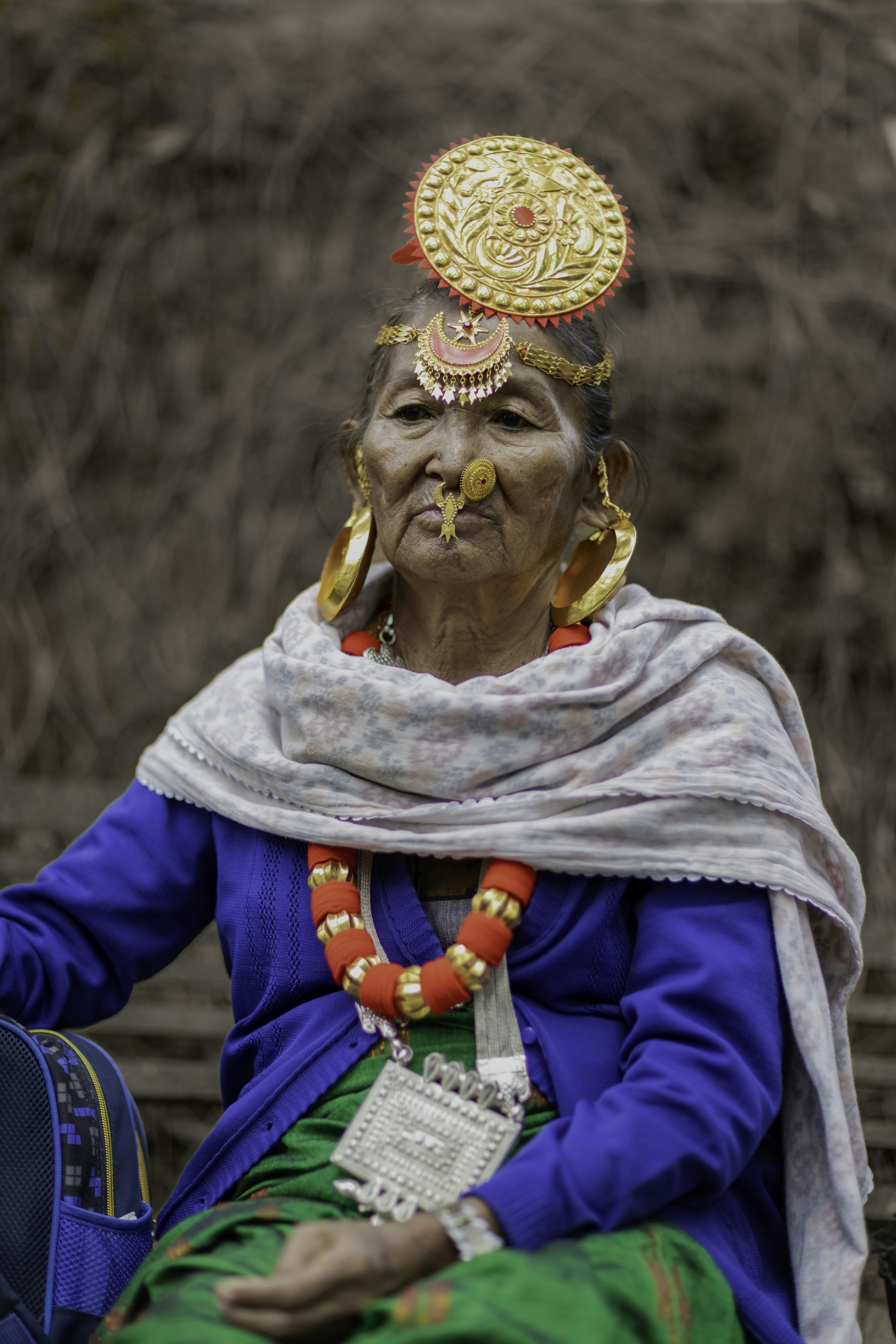 Face Adorned in Ceremony: The Elder in Colorful Regal Attire