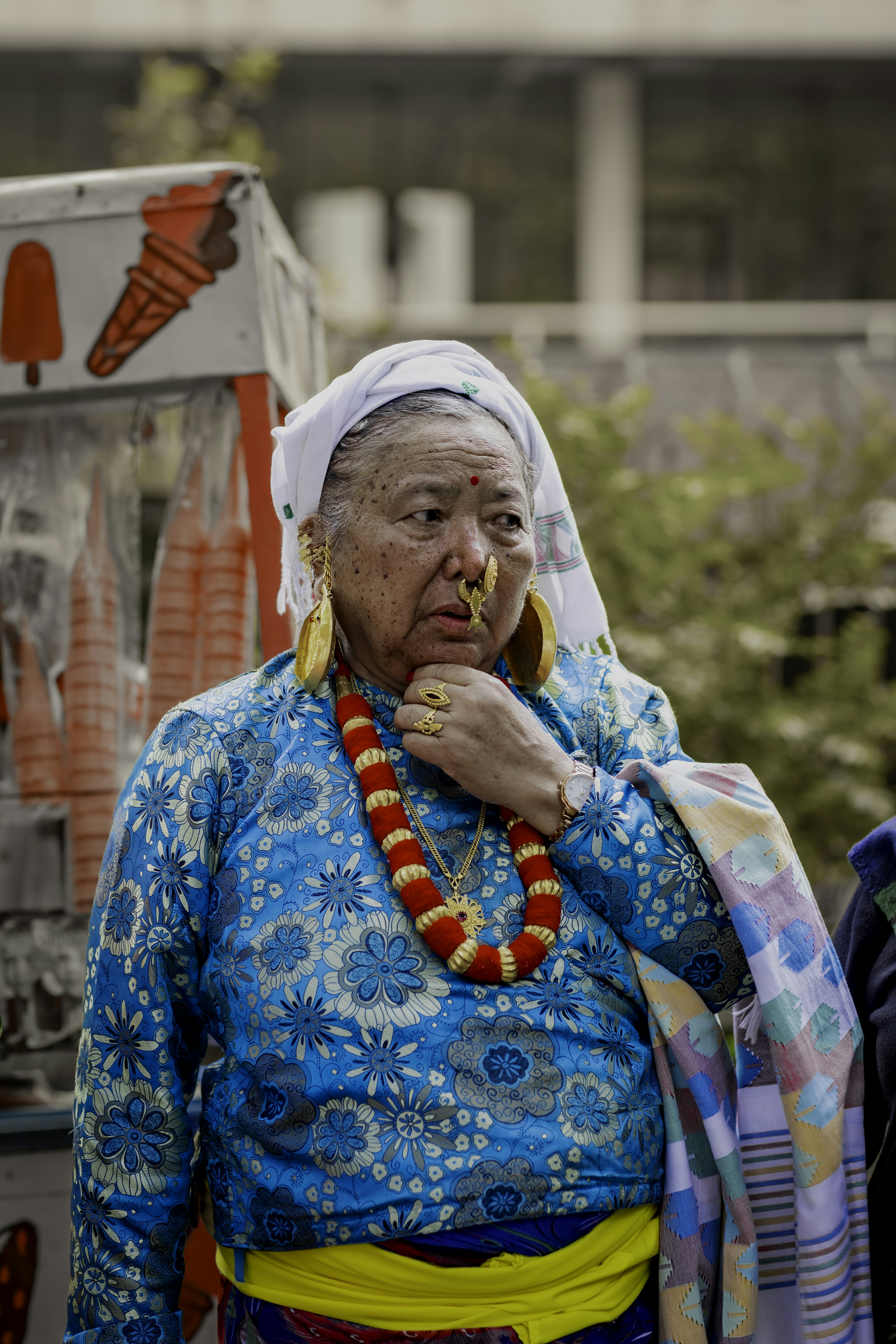 Ceremonial Colors: A Wise Elder in Turquoise Awakens the Street Market