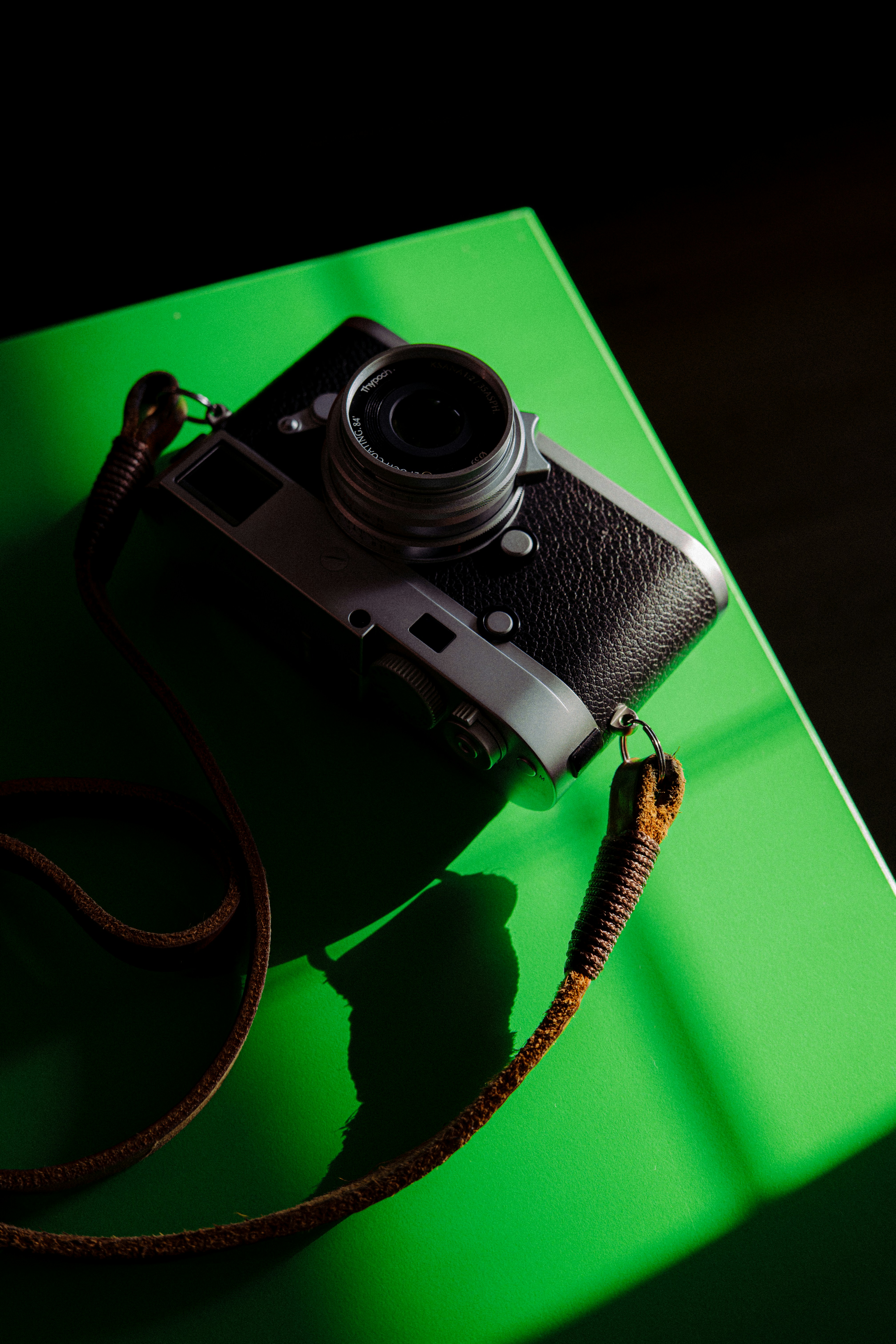 Retro Steel: A Compact Rangefinder Resting on Neon Green