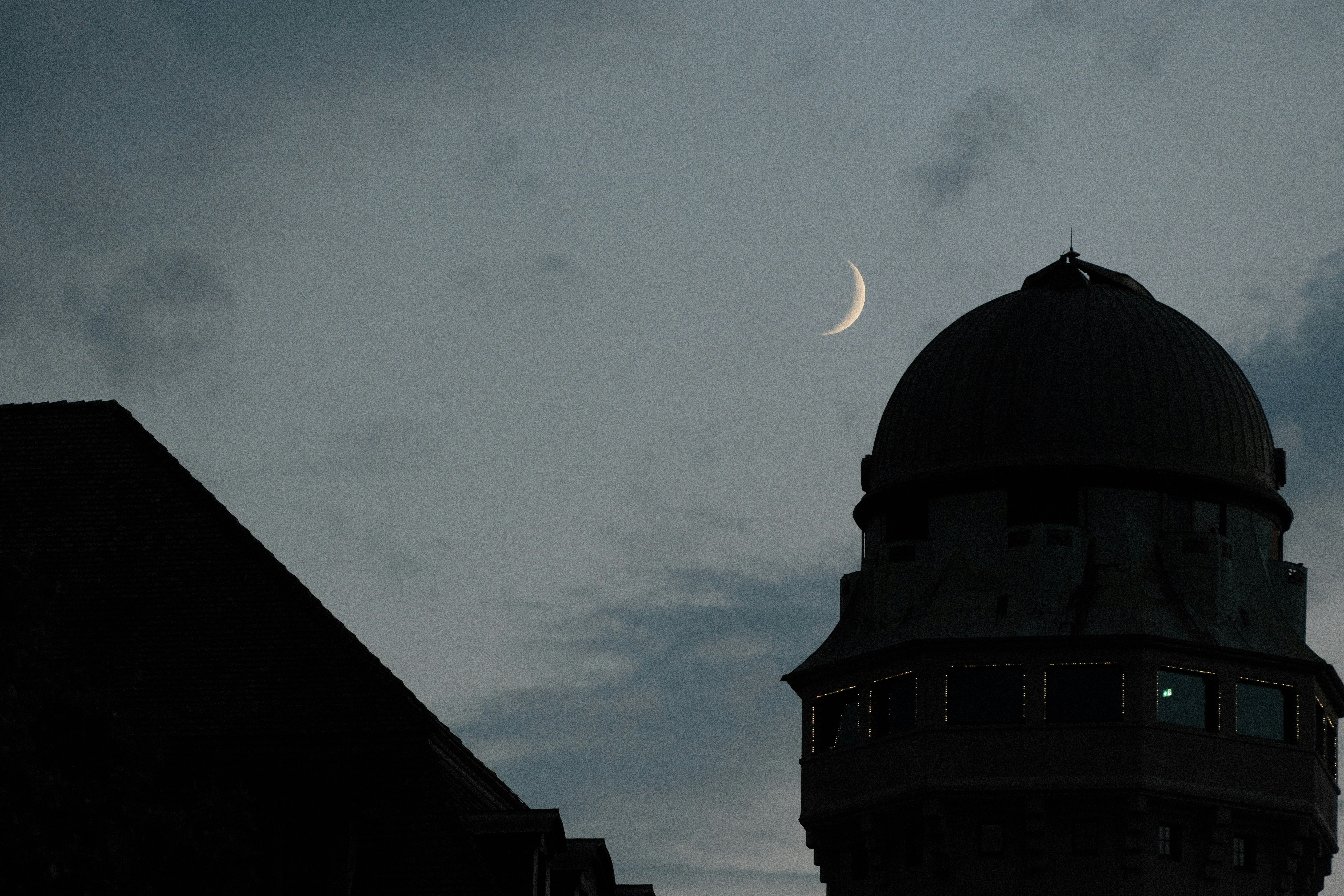 Crescent Over the Dome: Evening Skyline and Moon