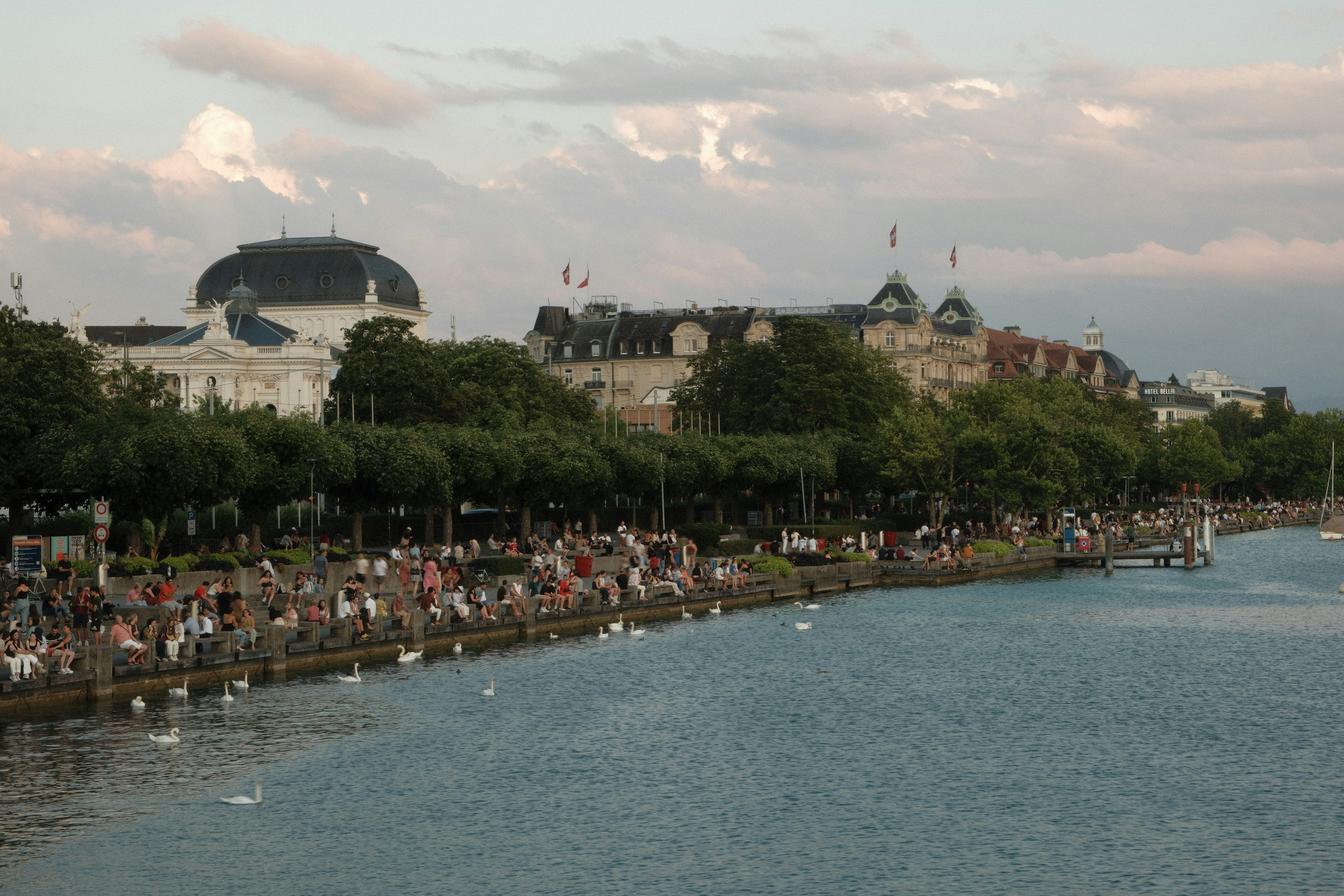 Crowd-Striped Bank: A Riverside Spectacle Along the City Edge
