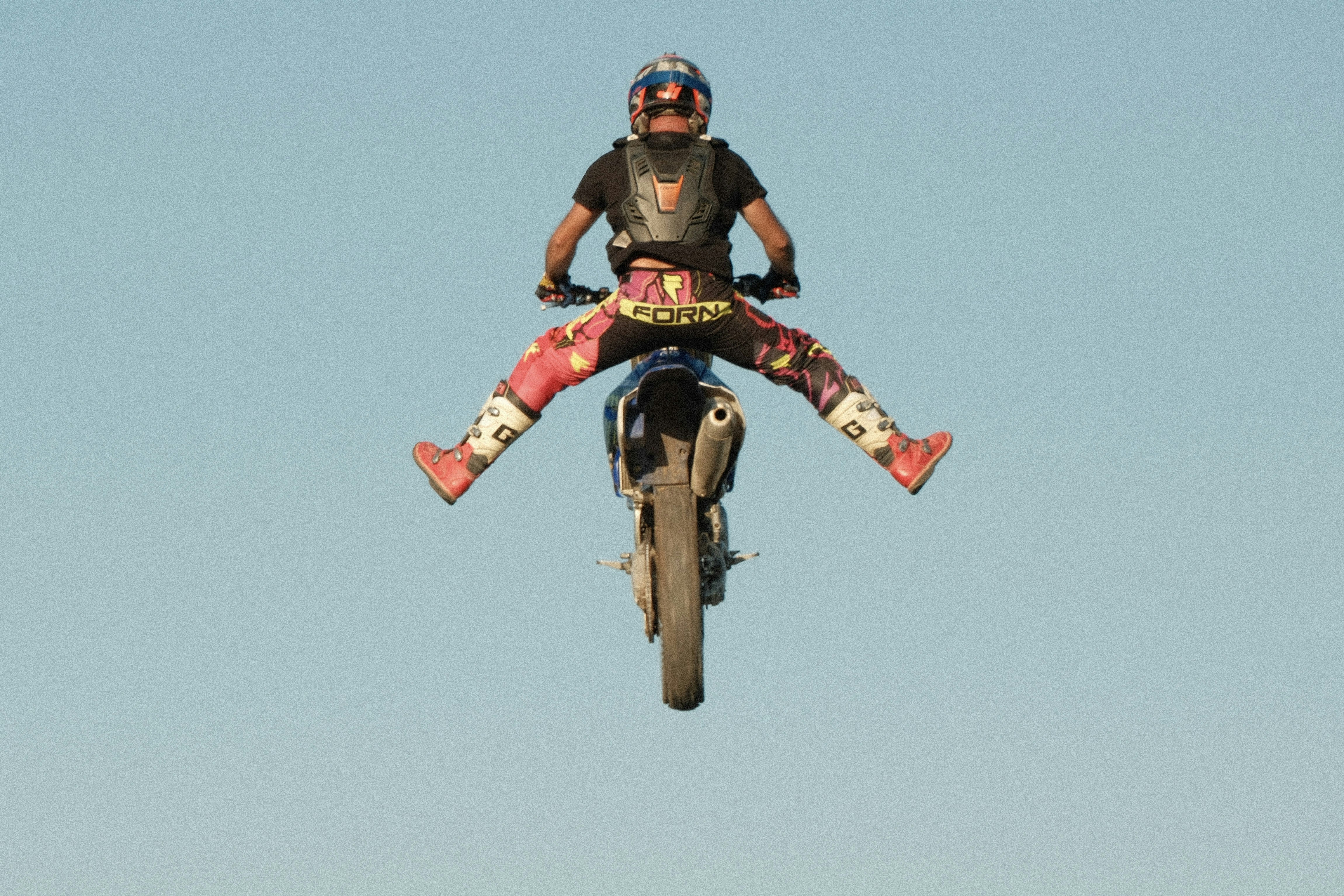 Mid-Air BMX: A Rider Defies Gravity Against a Clear Blue