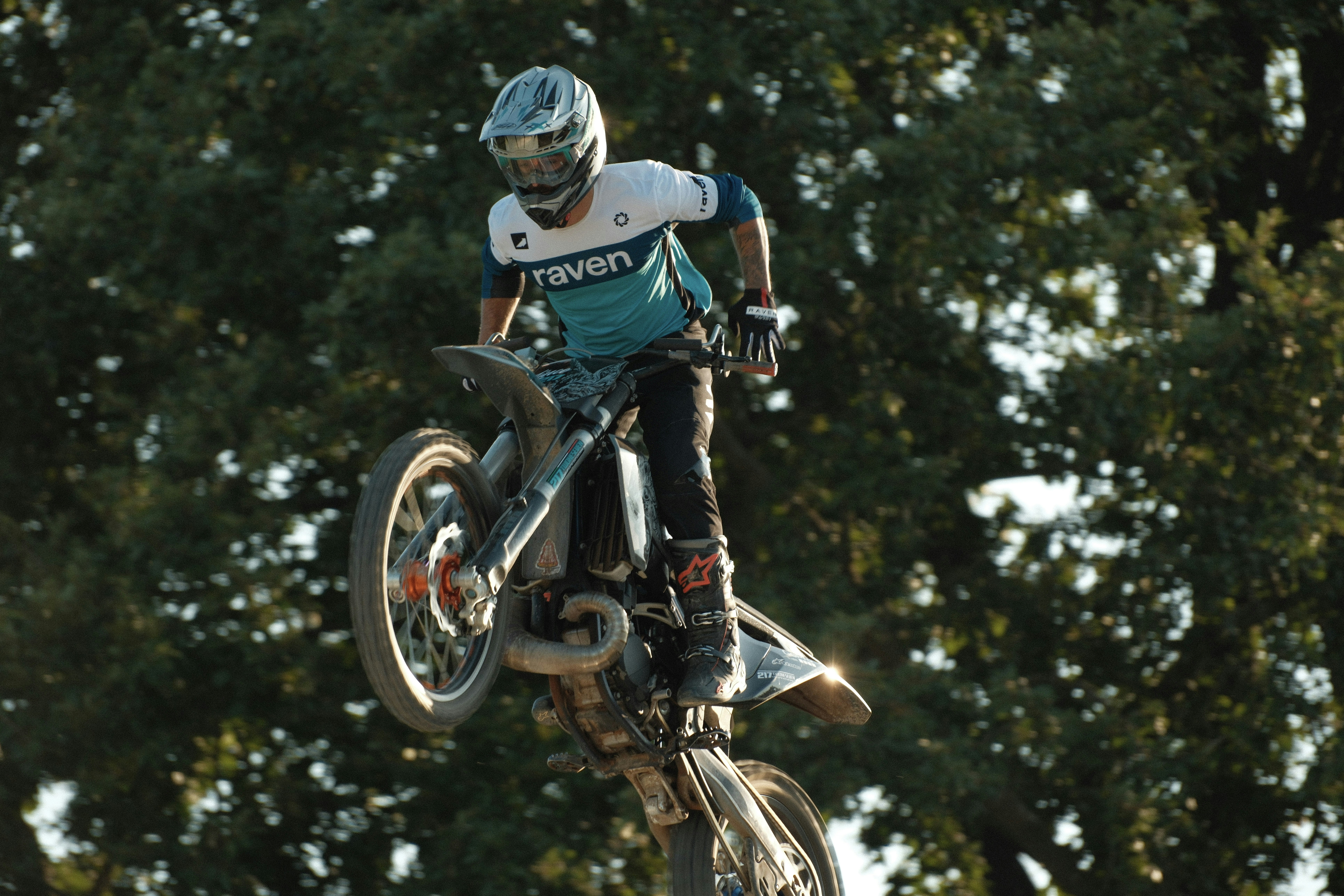 Mid-air Ride: Rider Leaps with The Trails in Bloom