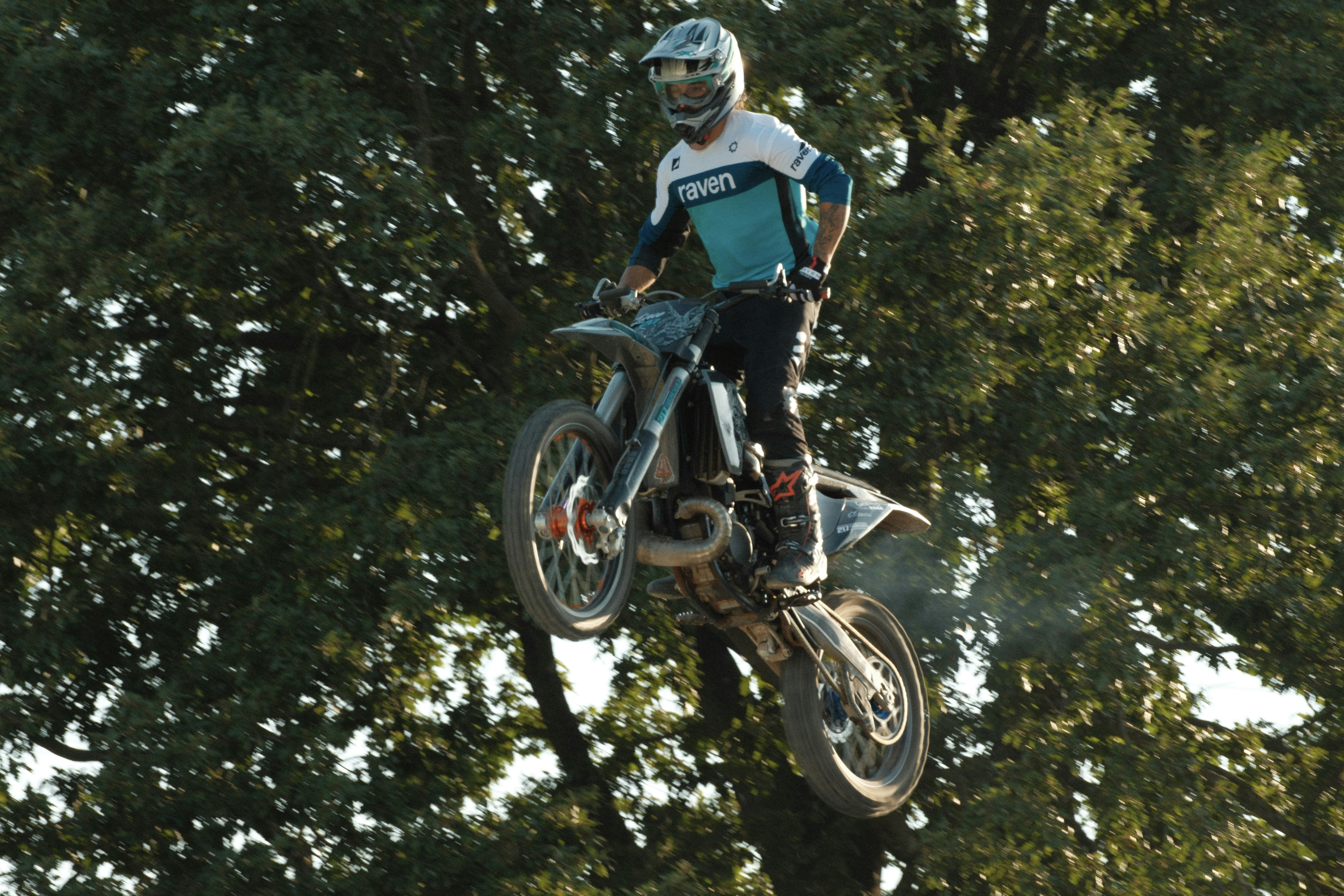 Midair Rider: A BMX Reach Above the Park Canopy