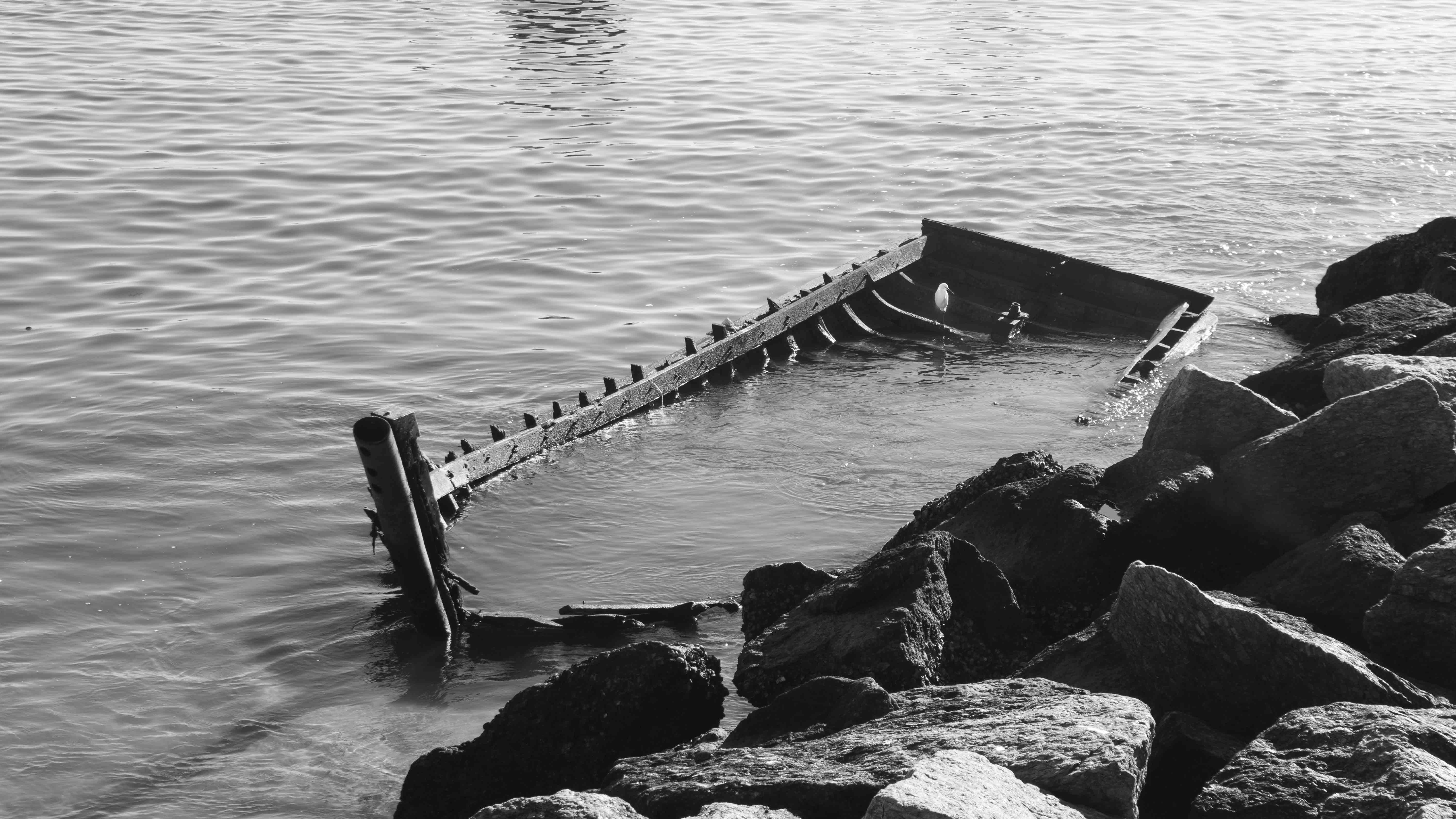 Silent Dock: A Sunken Pier Among Quiet Rocks