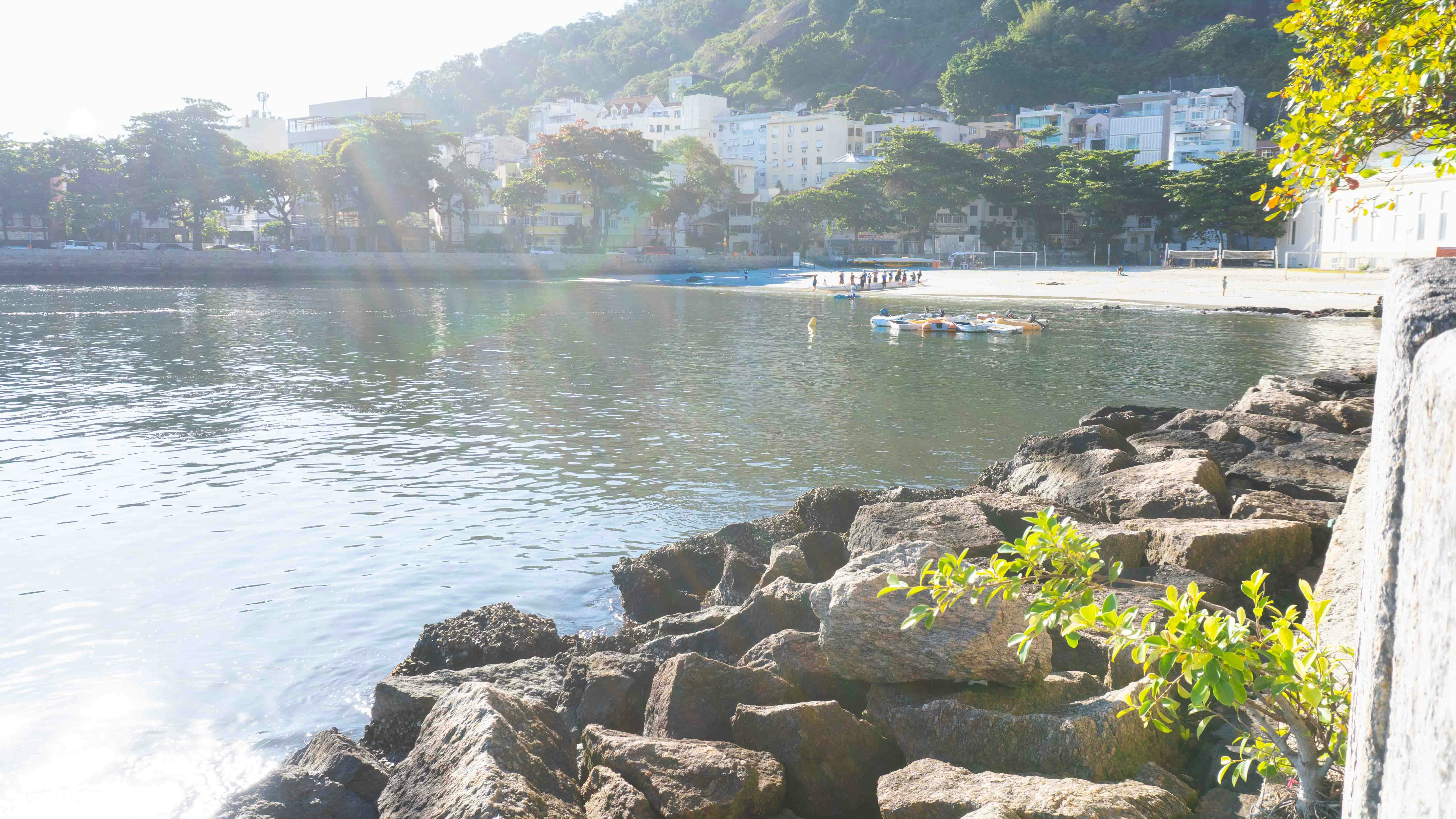 Rugged Breakwater and Quiet Bay: Sunlit Waterfront Village