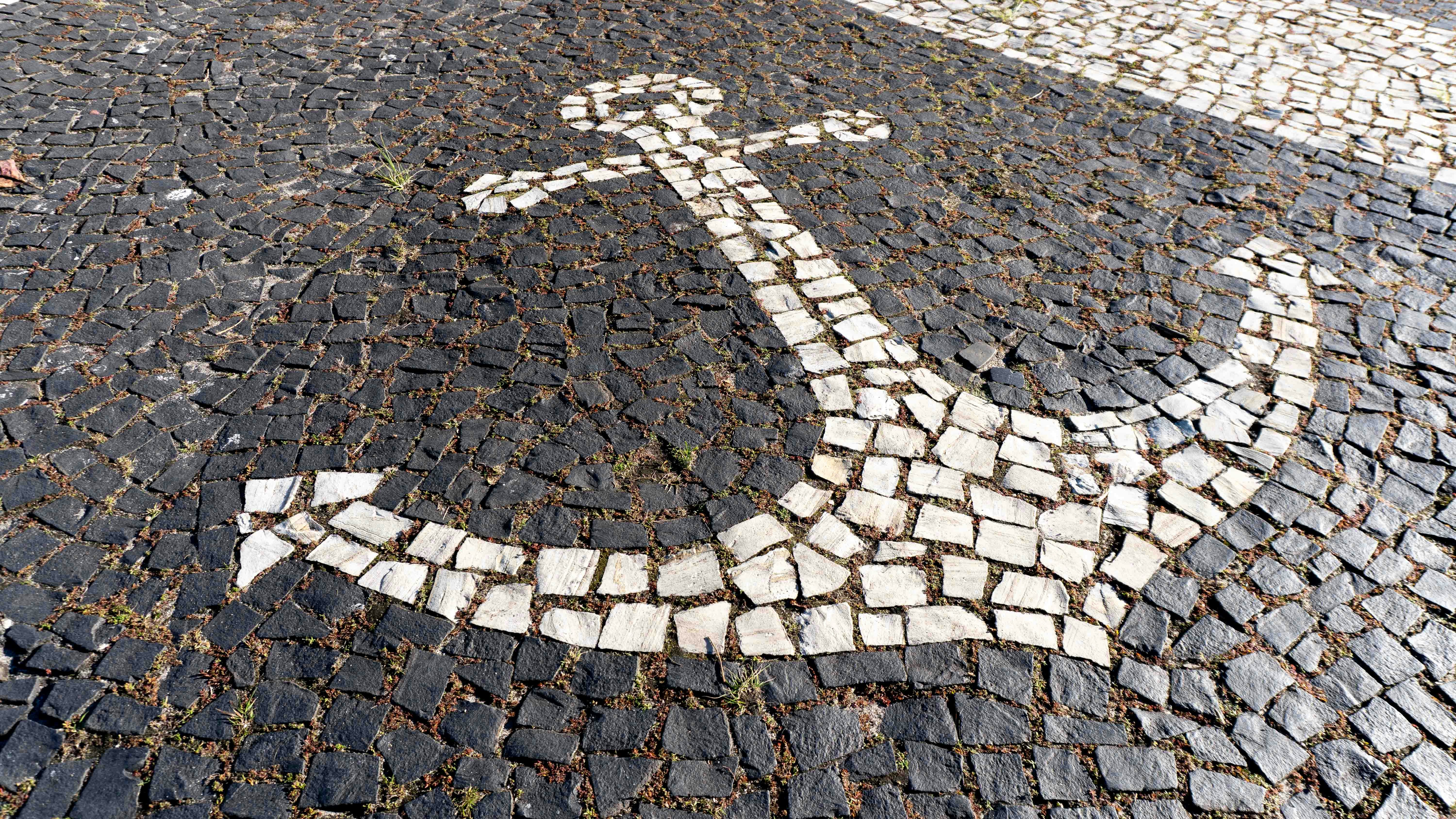 Curved Mosaic Path: A Pedestrian Accessibility Mark on Cobblestones