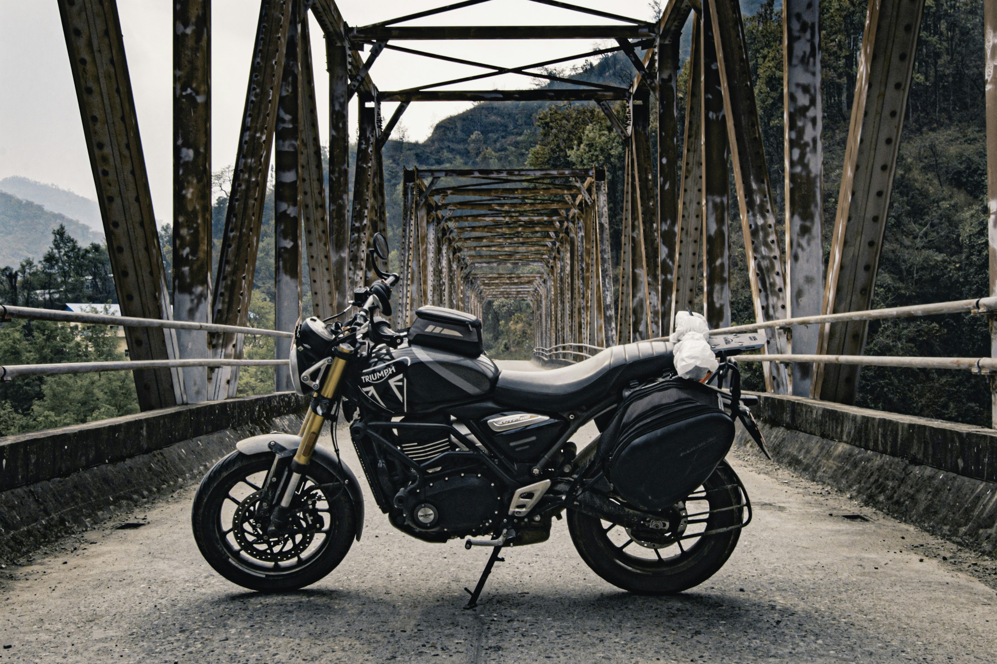 Steel Rider on a Silent Span: Motorcycle Pauses on an Old Bridge