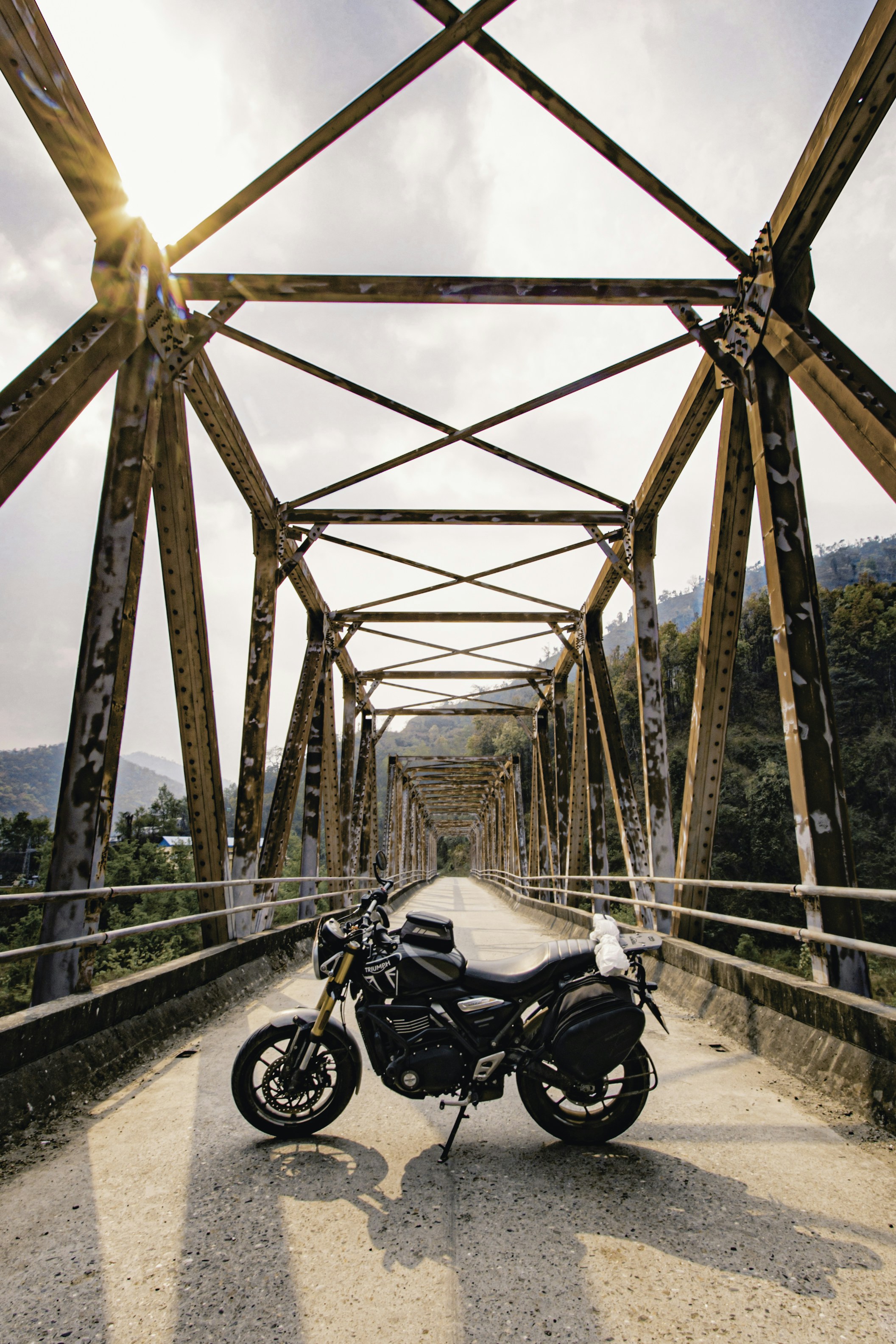 Crossing Frame: A Lone Motorcycle on Sunlit Rails