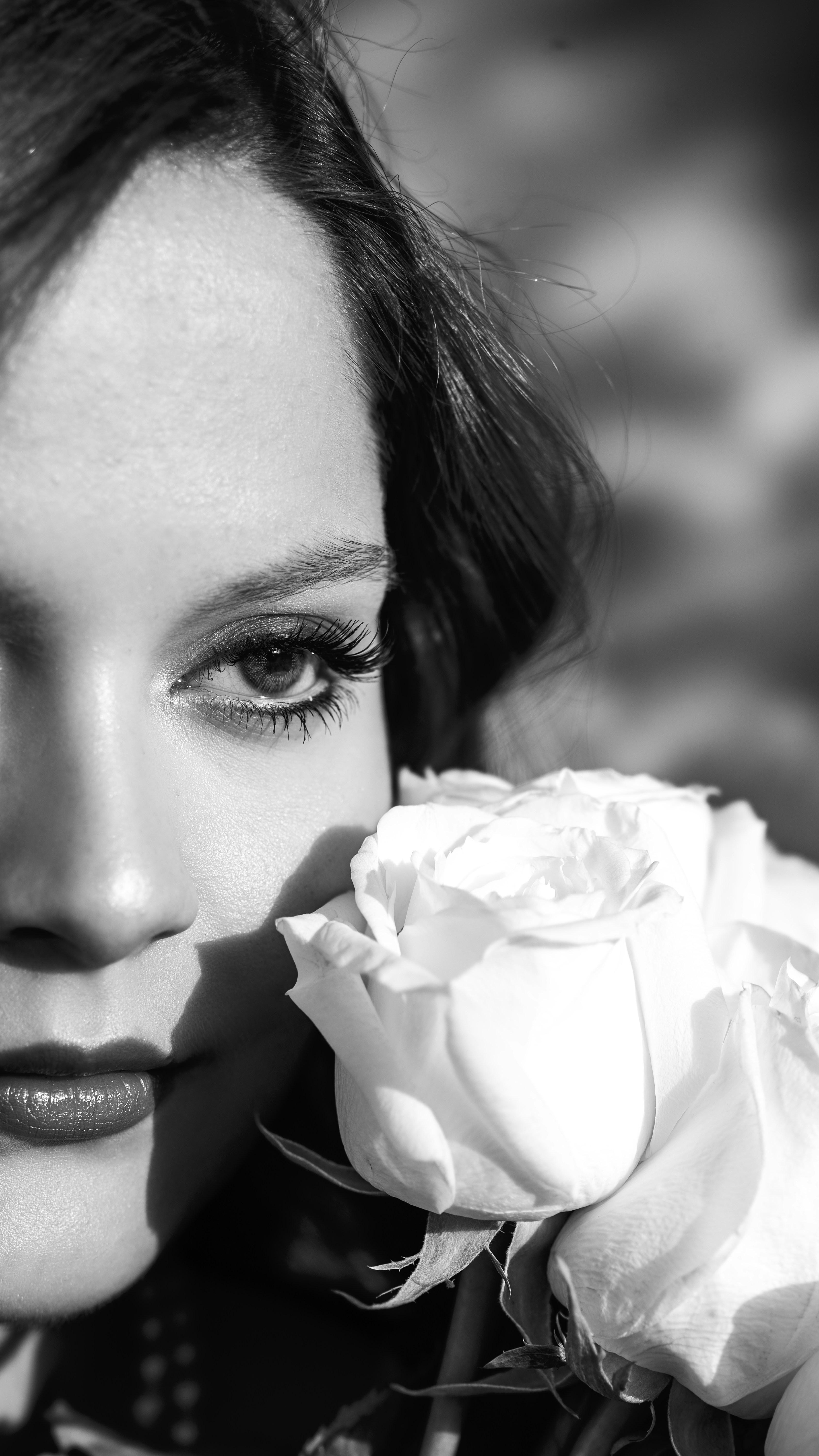 Close-Up of a Whispered Moment: A Rose Near Soft Focus Eyes