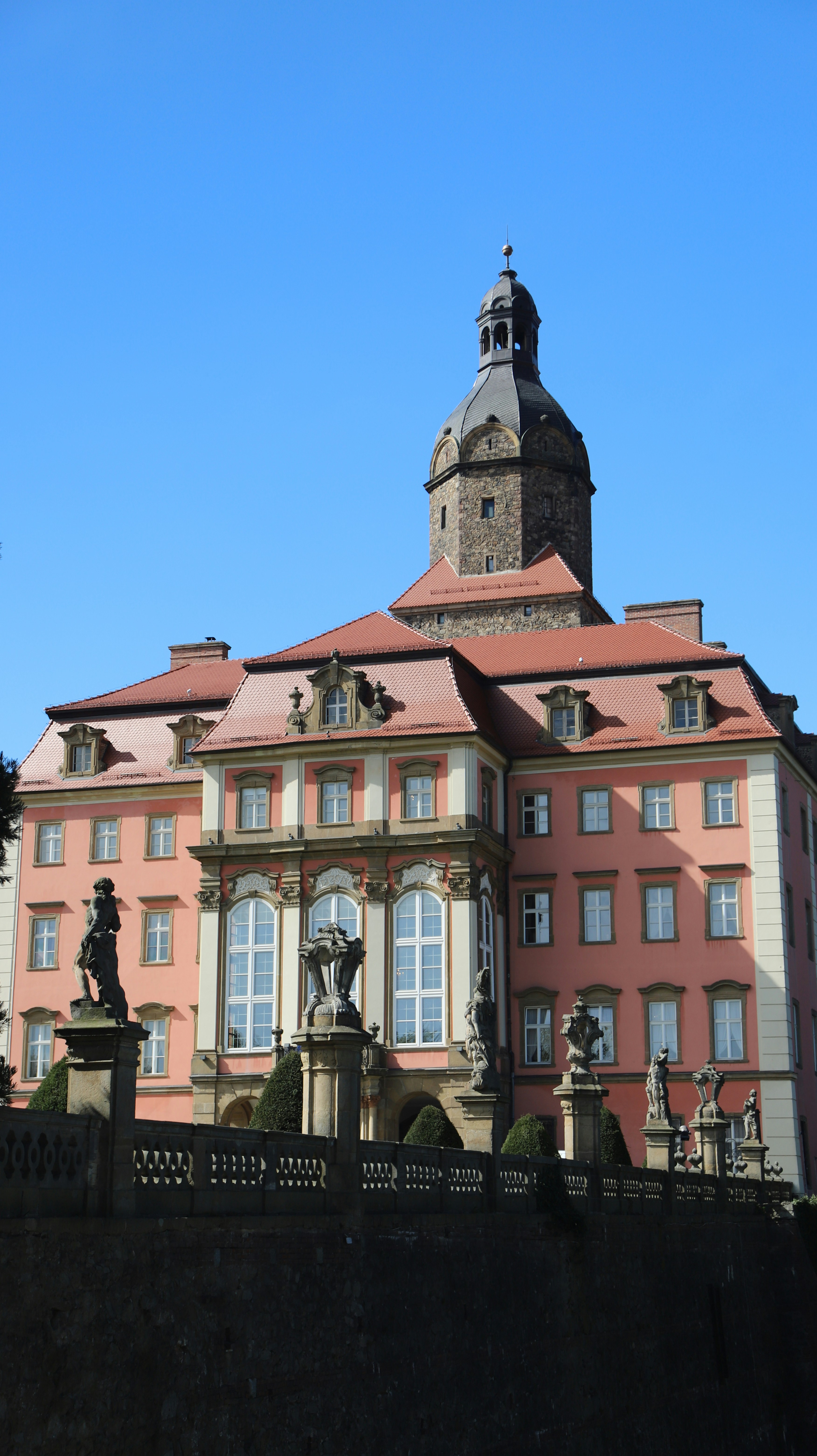 Blush Facade: A Baroque Palace Under a Clear Blue Sky