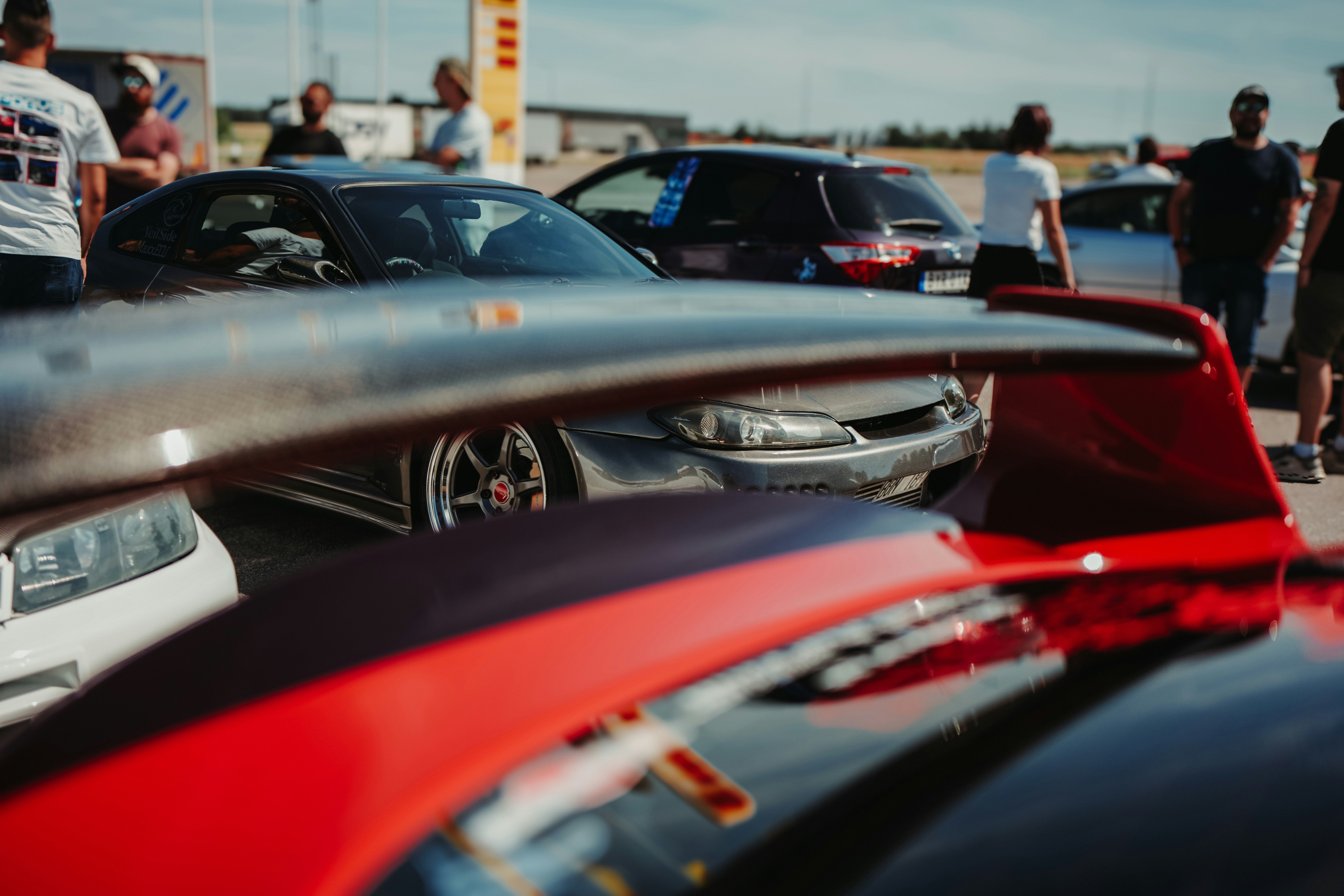 Rear-View Rally: A Glimpse Through Glossy Car Surfaces