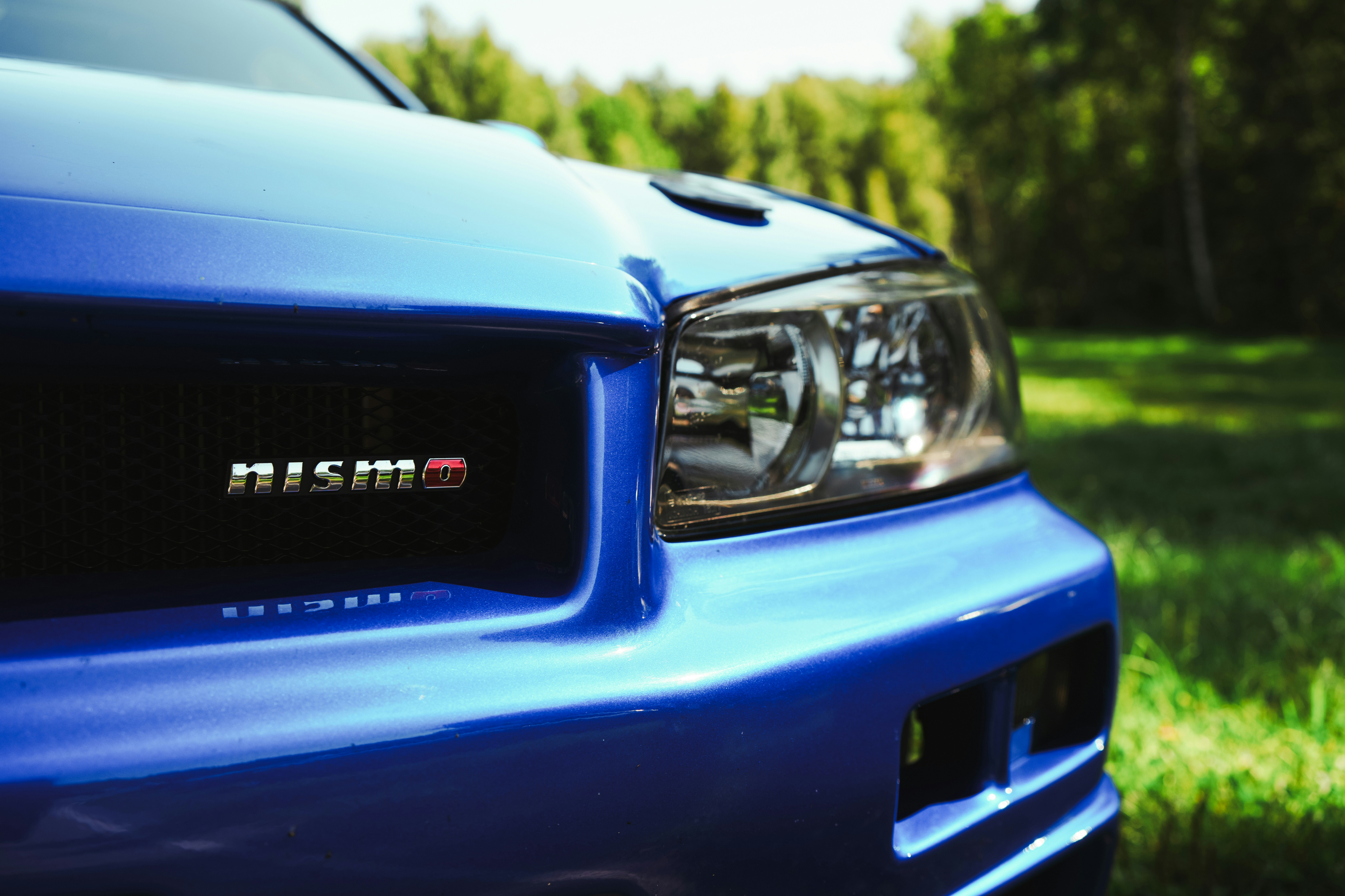 Blue Nissan Skyline Wardrobe: A Close-Up of a Nismo Badge Glow