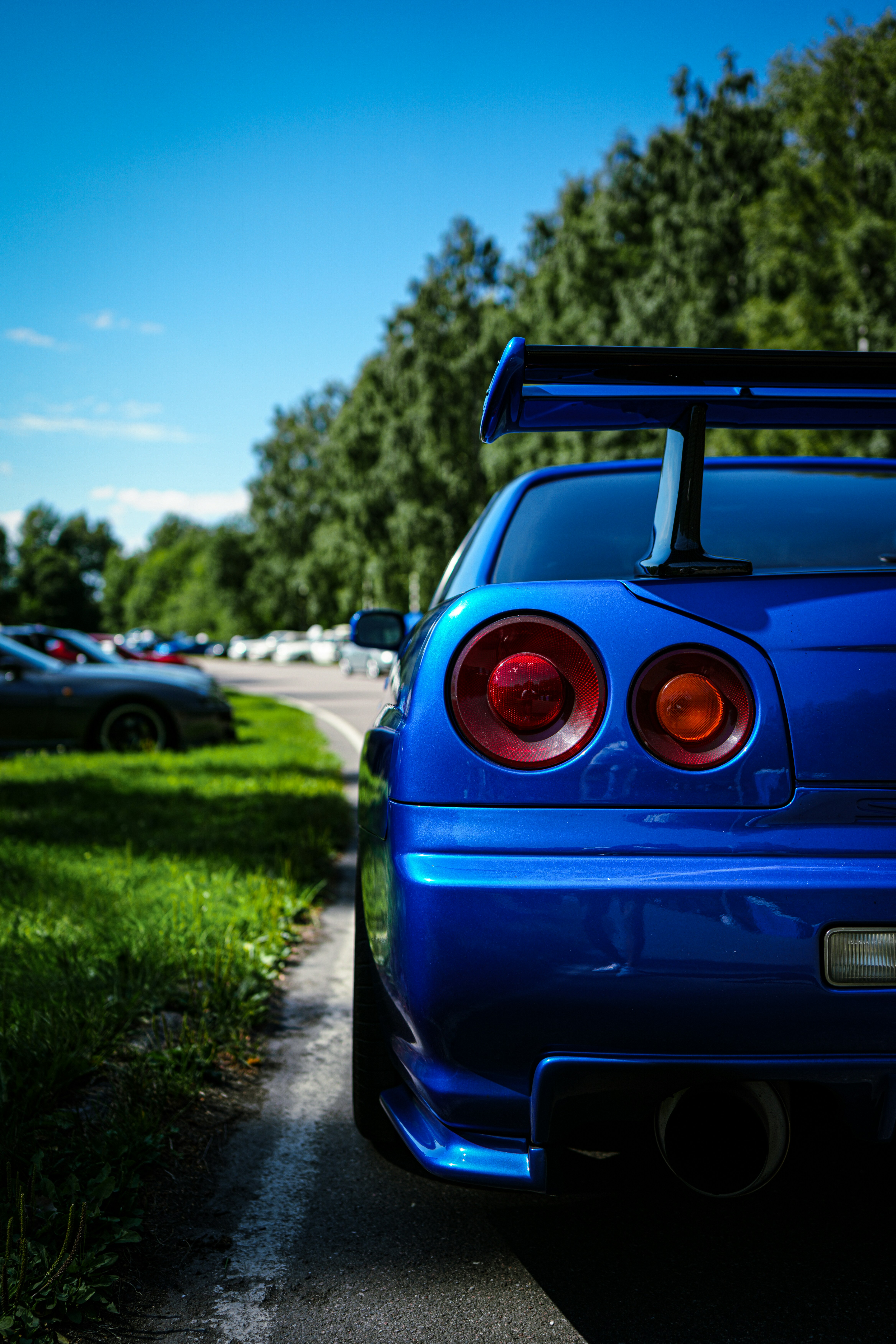 Blue Skyline: A Sporty Coupe in a Parking Lot Spotlight