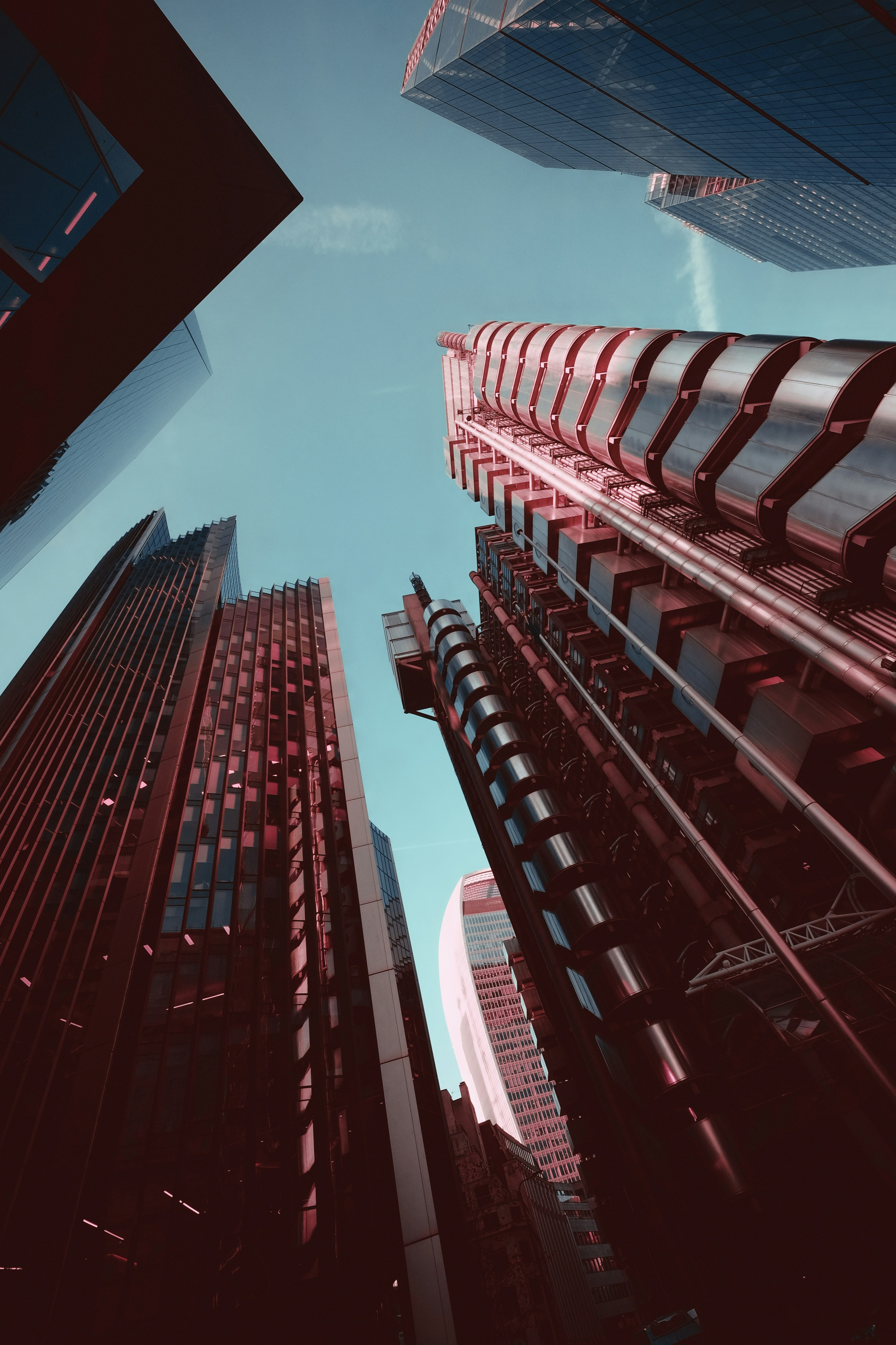 Skyward Convergence: A Neon-Red Perspective Through High-Rield Facades