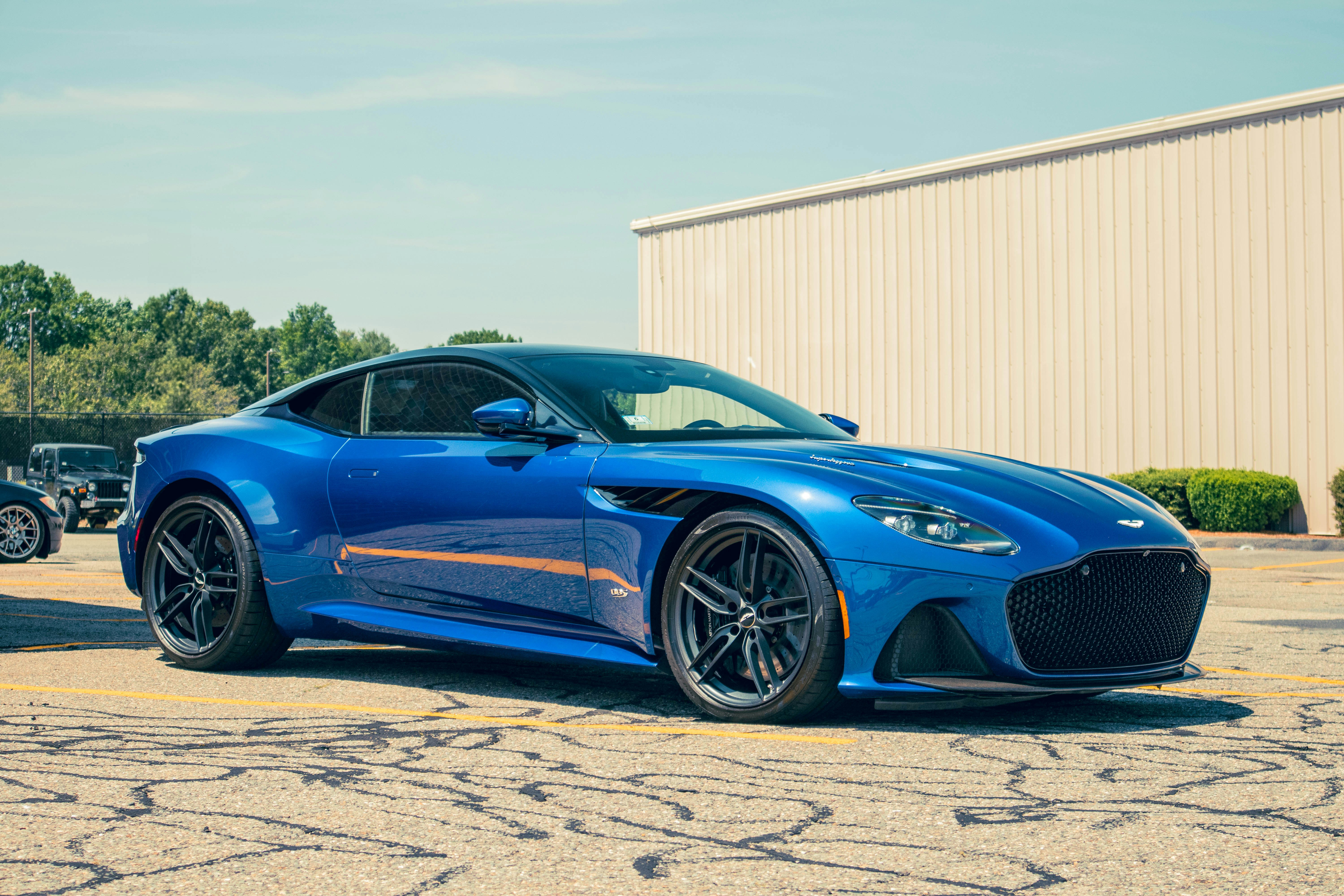 Azure Velocity: A blue sports coupe stance in a sunlit lot