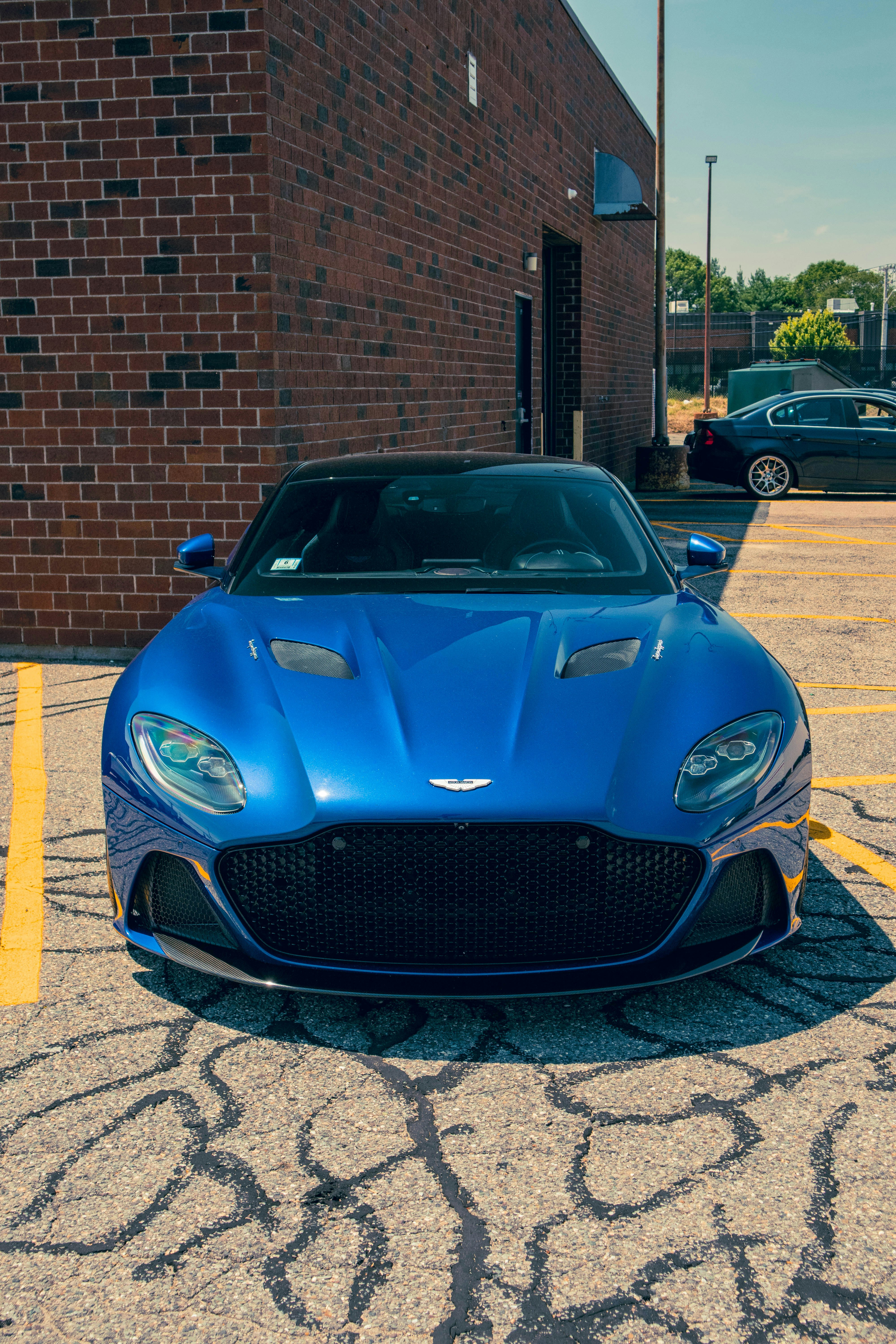 Blue Aston Martin in a Sunlit Parking Lot