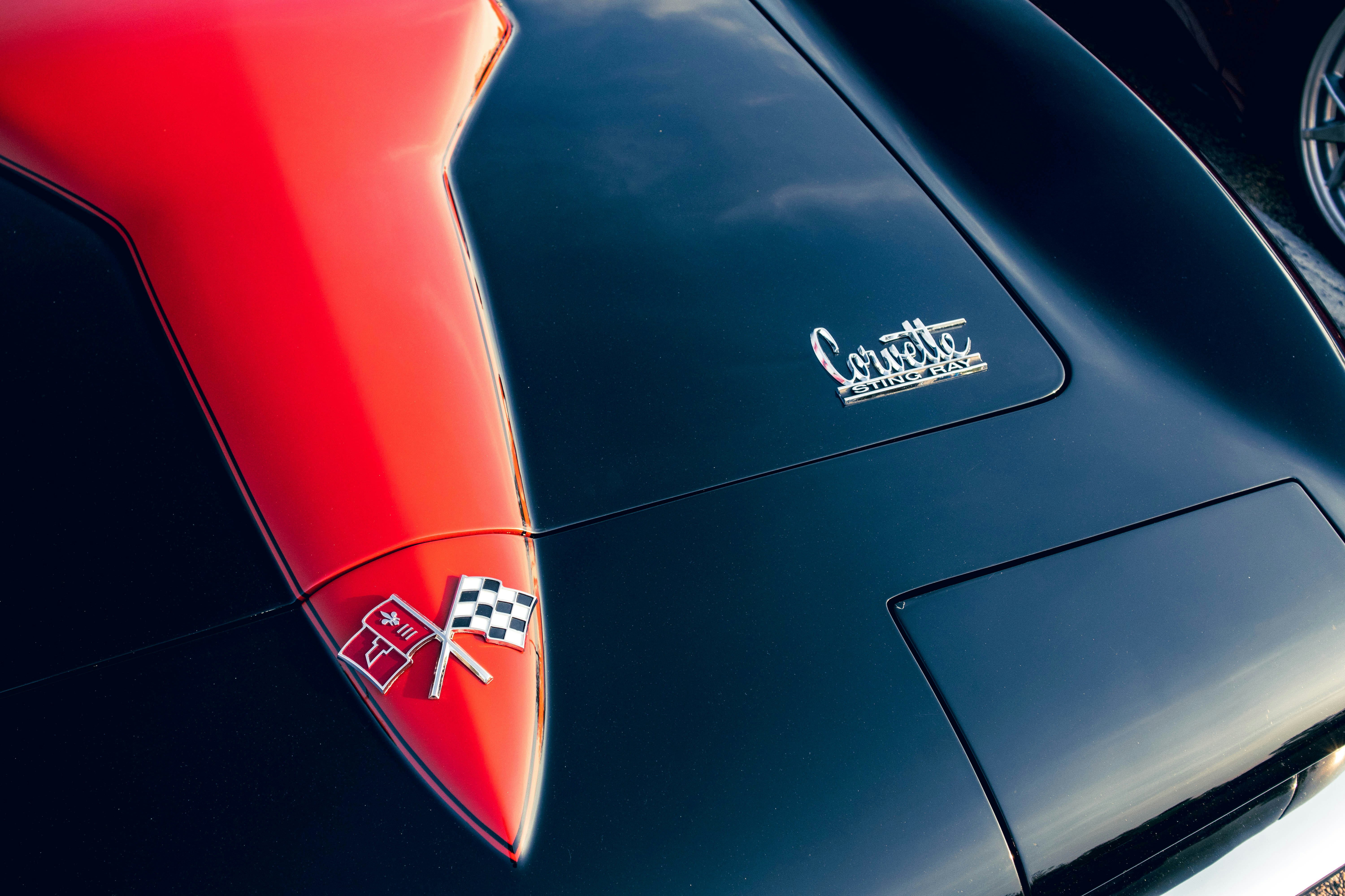 Red-Blue Tension: The Corvette Hood Embraces a V-Glimpse