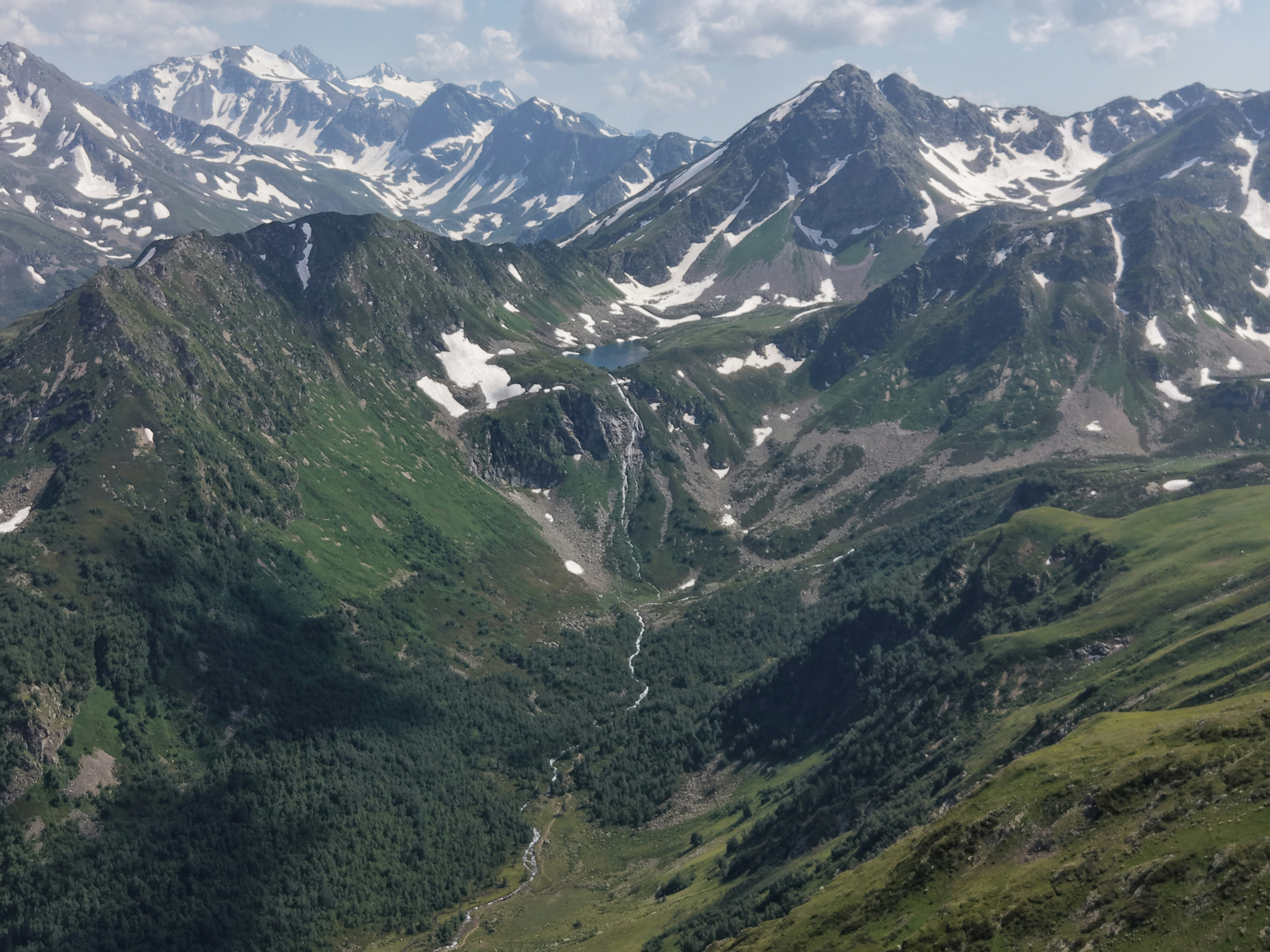 Vals of Silence: Snow-dusted Peaks Crowned by Green Valleys