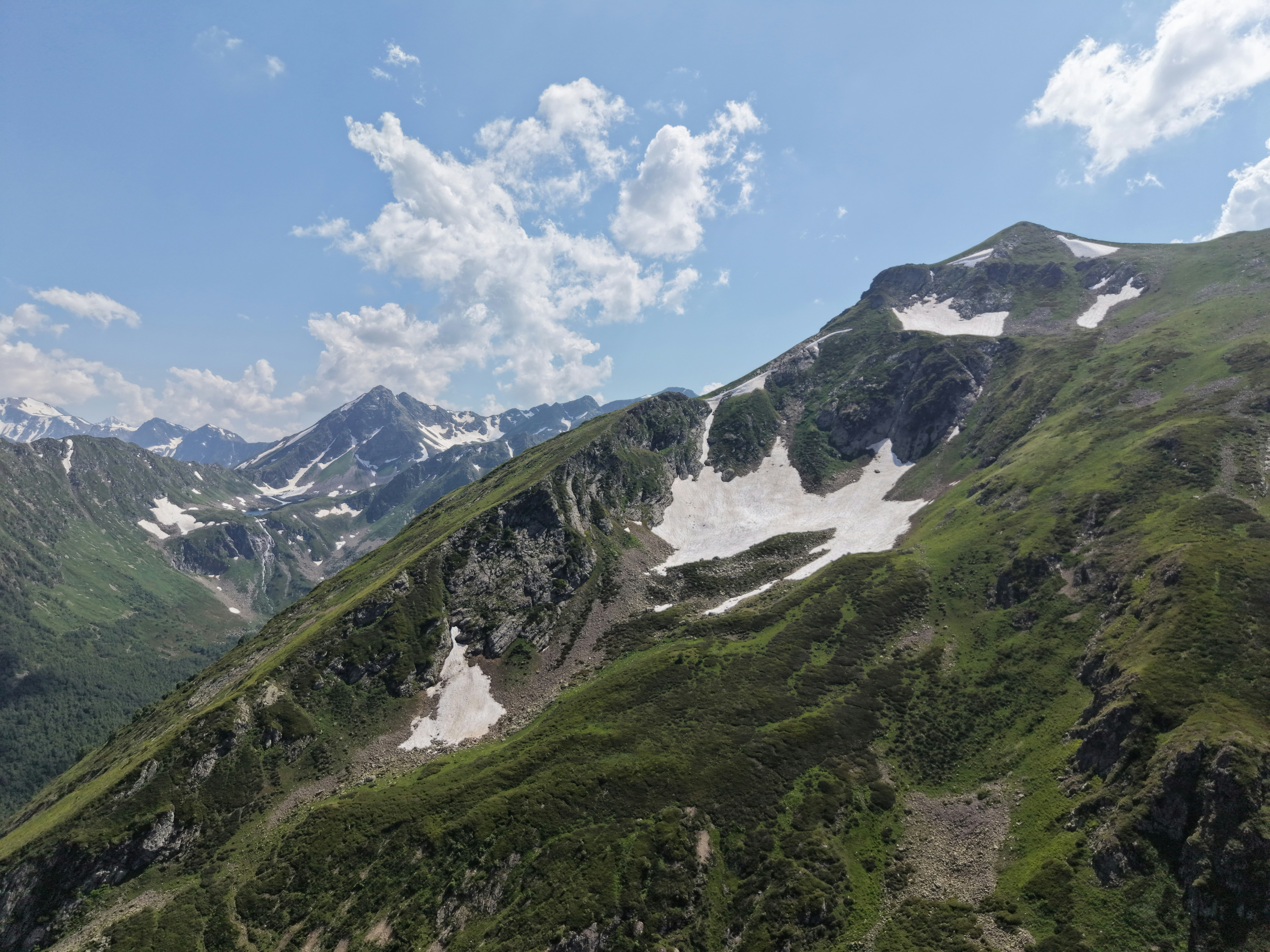 Snow-kissed Peaks Under a Bright Alpine Sky