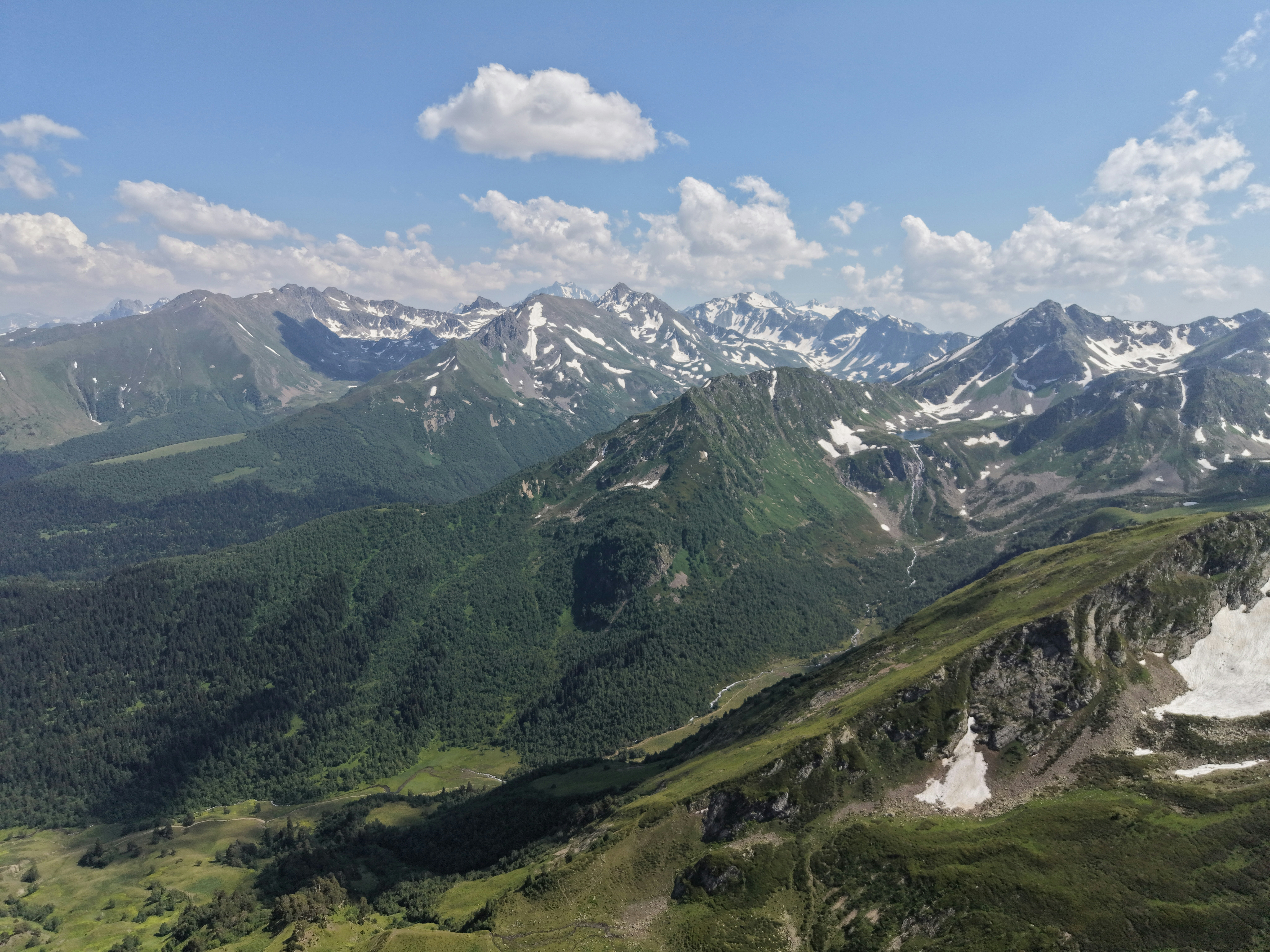 Snow-kissed Ridge Panorama under a Bright Alpine Sky