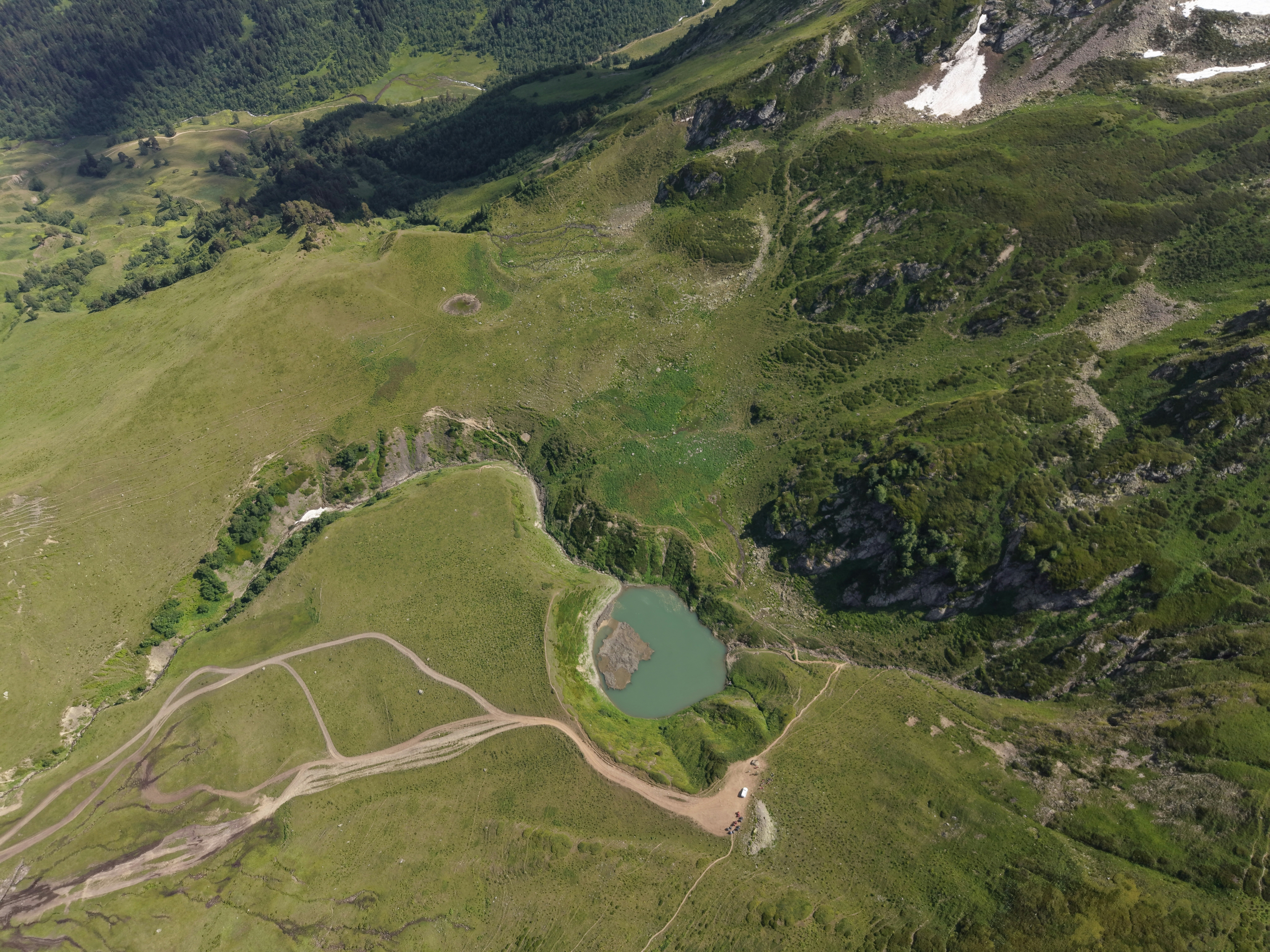 Verdant Ridge with Alpine Tarn: Aerial Crossroads