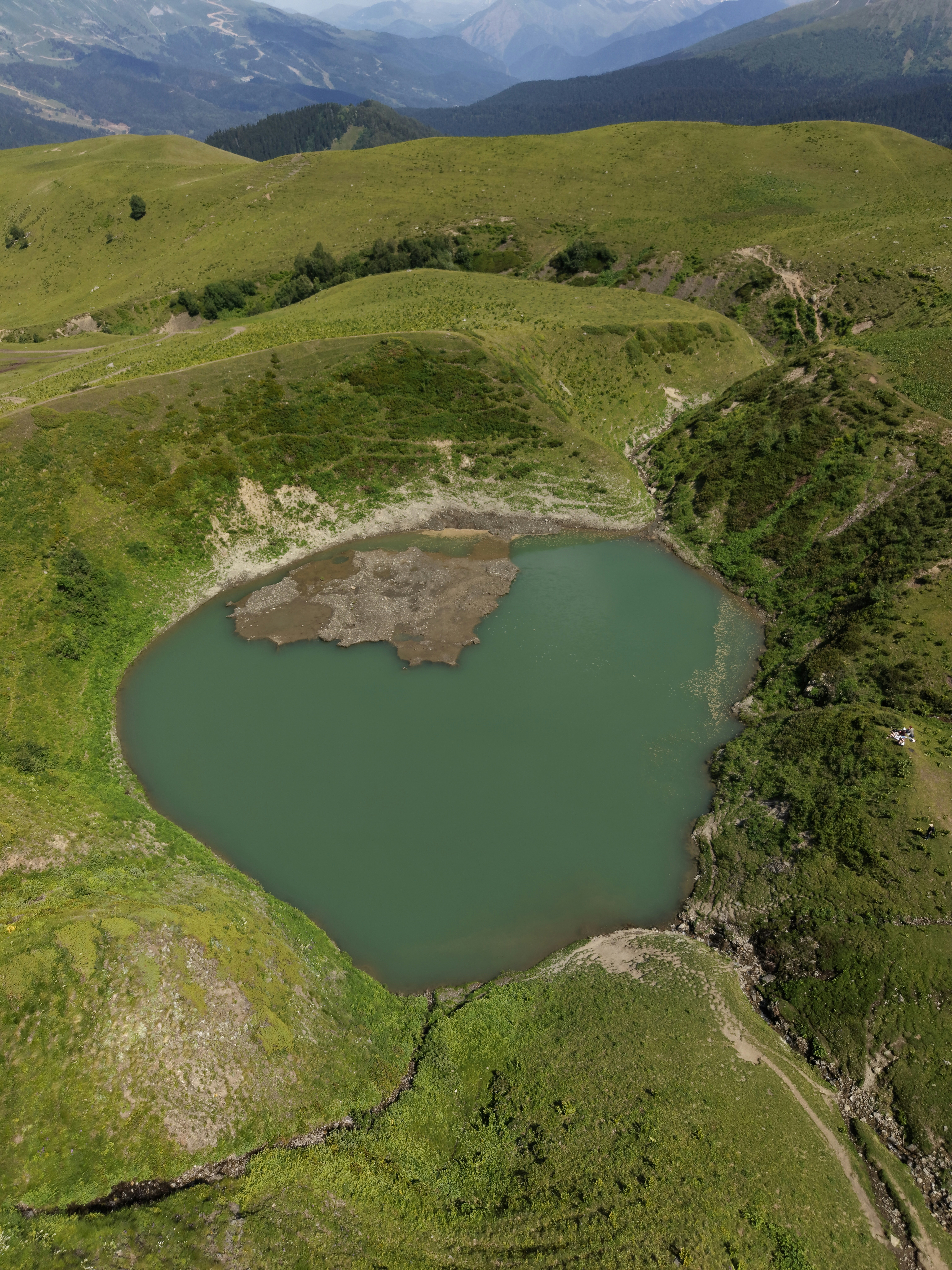 Aerial View of a Green-Sloped Crater Lake