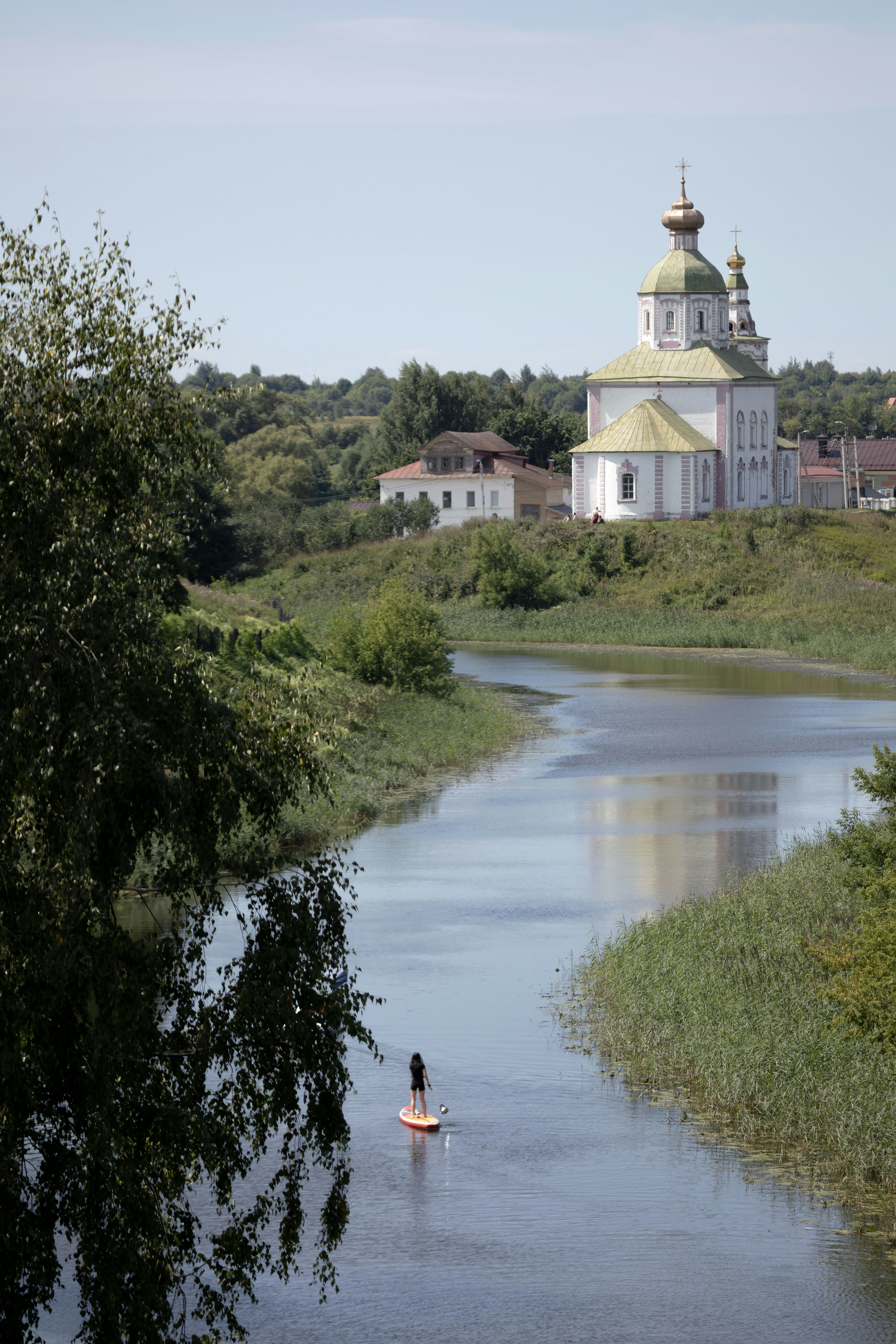 Riverbend Sanctuary: A lone paddle glides toward the church at the bend