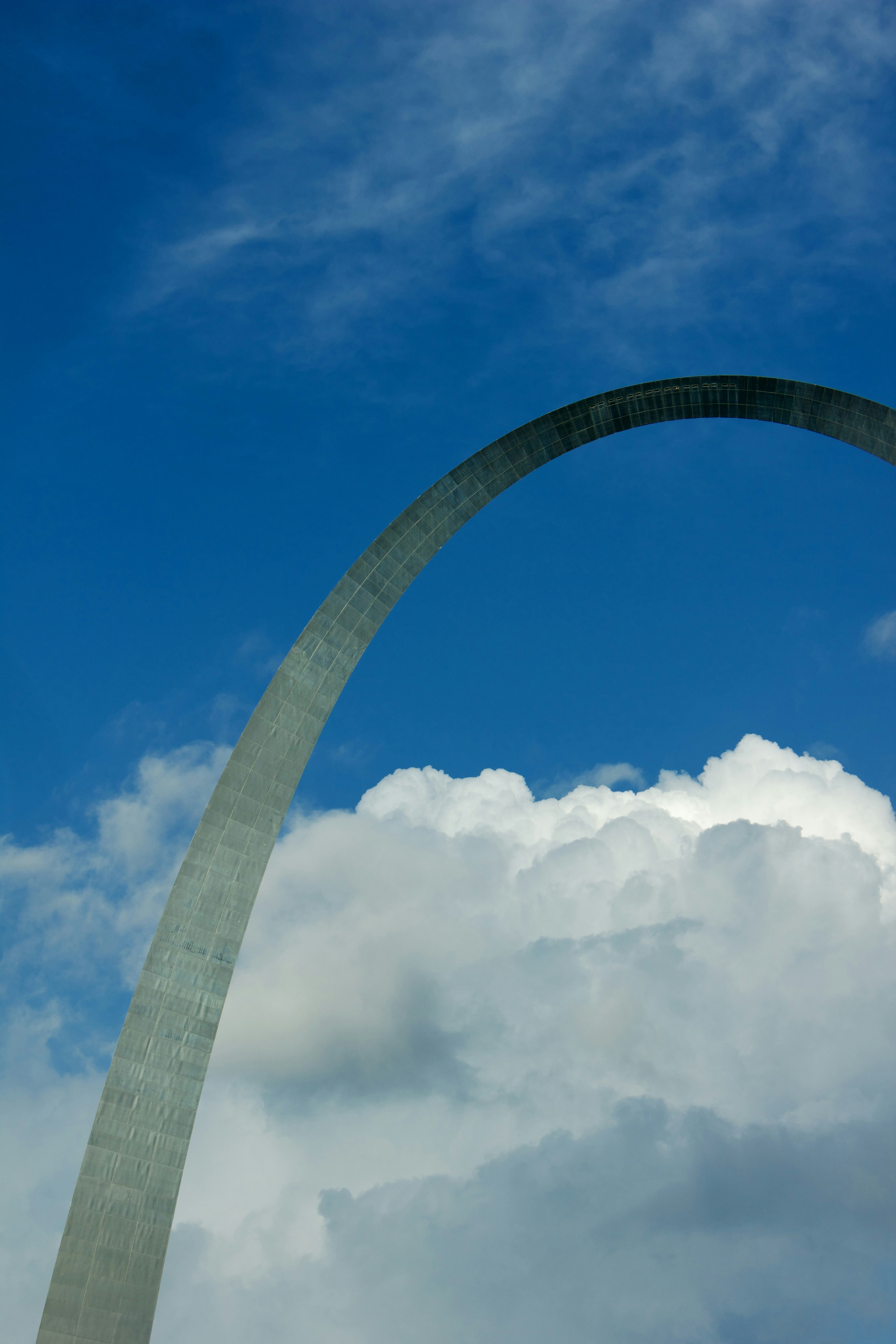 The Gateway Arch rising above dramatic summer clouds in St. Louis, Missouri.