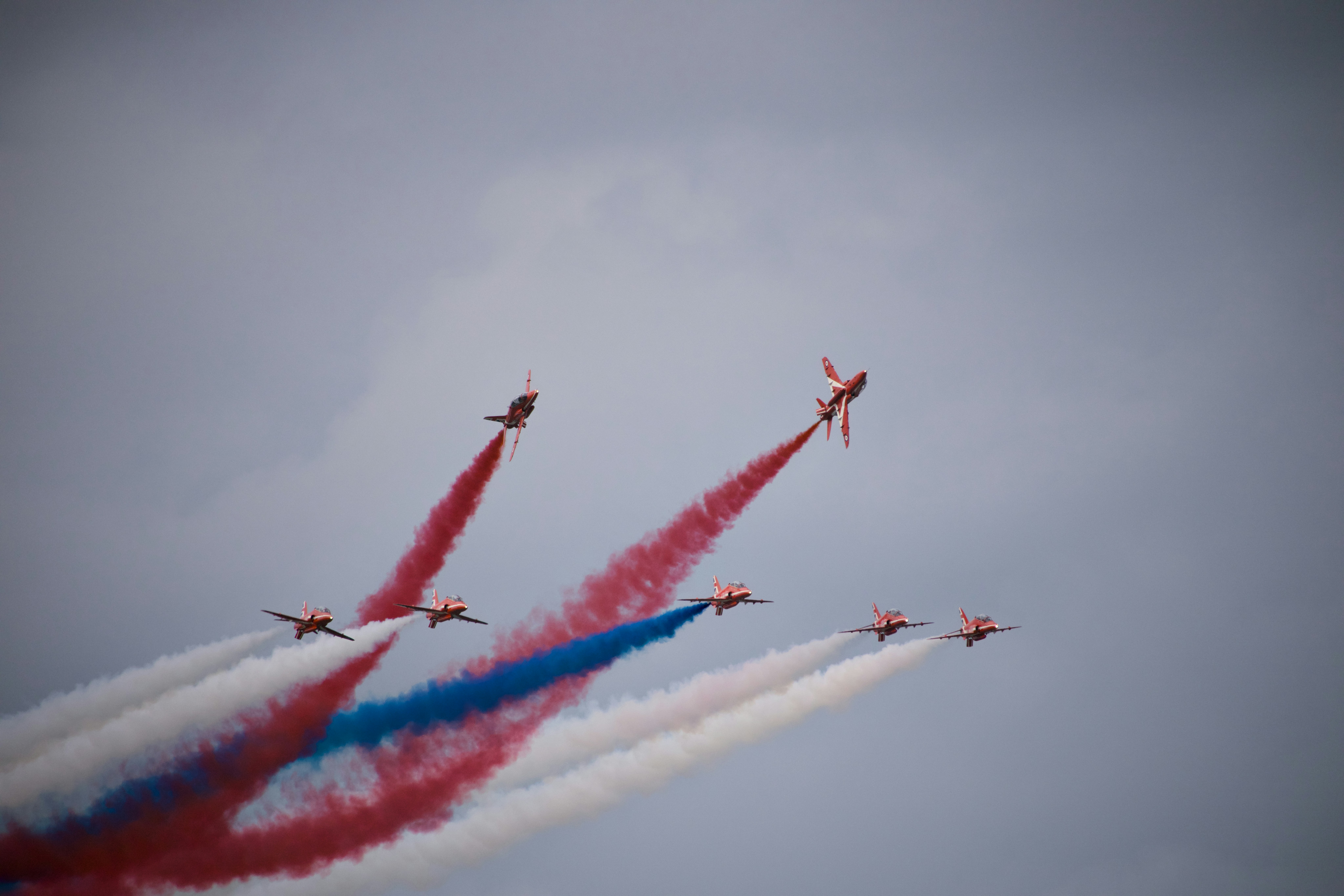 Aerial Colors: Red, Blue, and White Trails Across the Sky