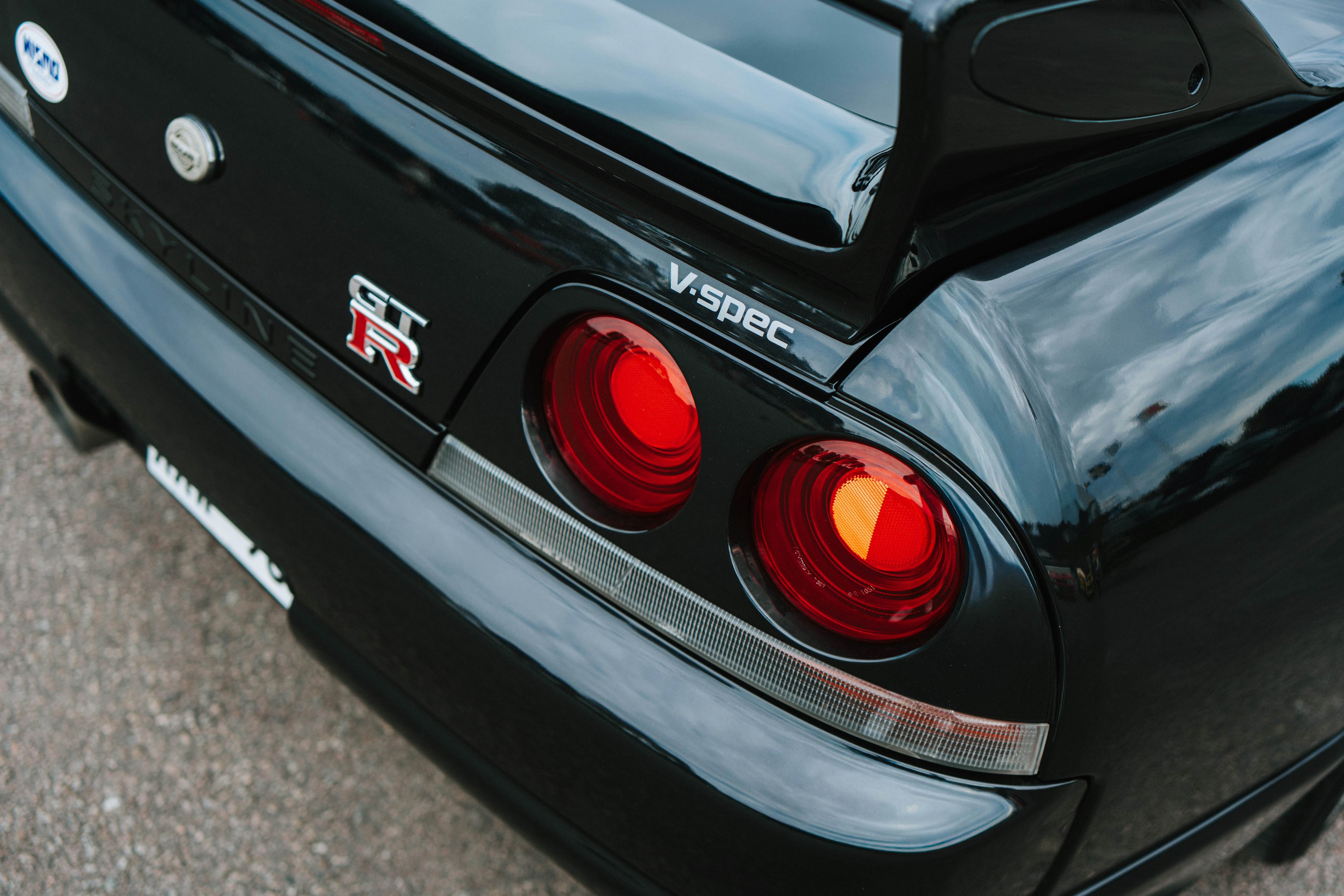 Tail lights and badge of a Nissan GT-R silhouette in glossy black
