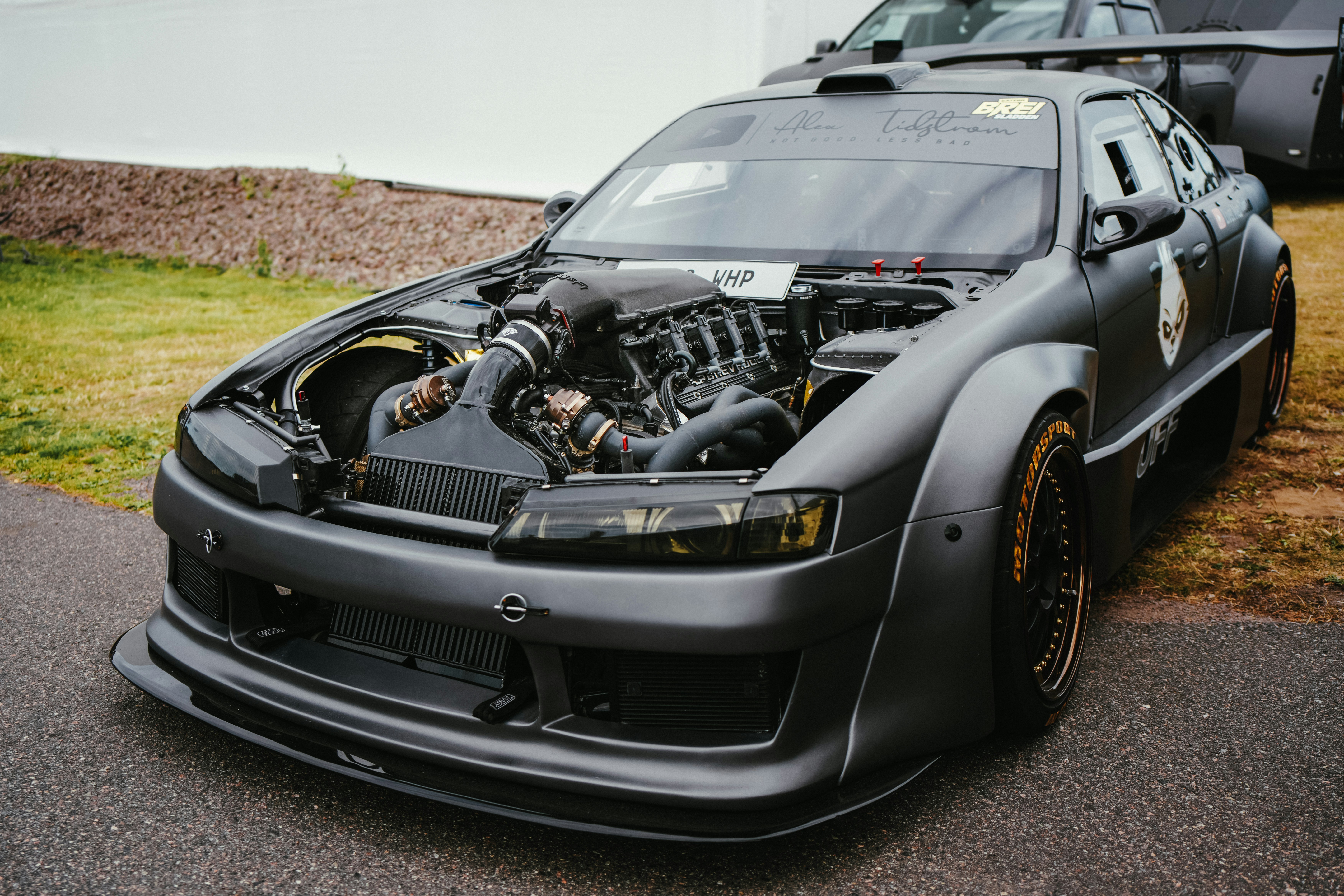 Aggressive mid-engined silhouette: a matte MR-style drag car with exposed turbo and hood vents