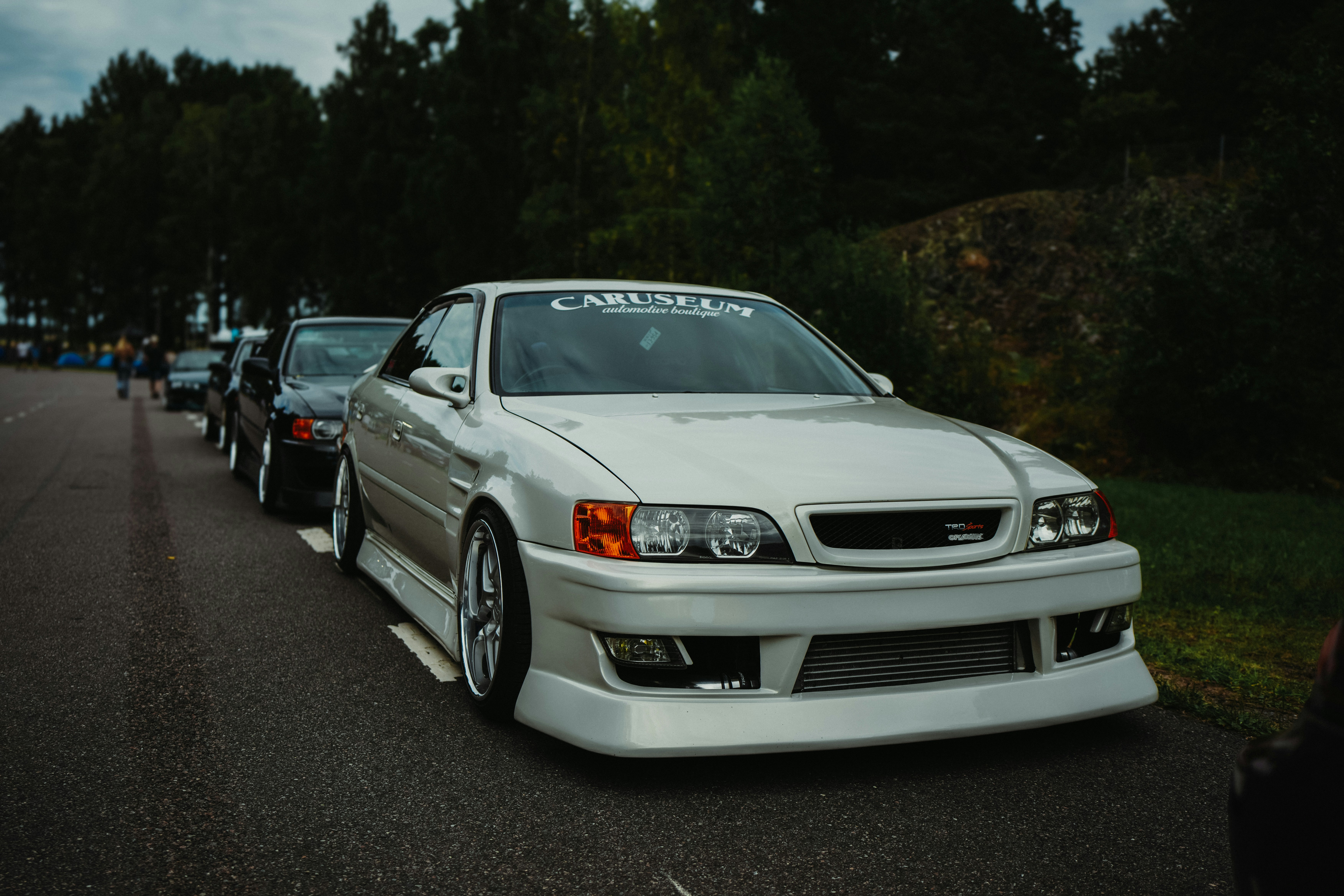 White Enthusiast Sedan Lines Up for the Lane